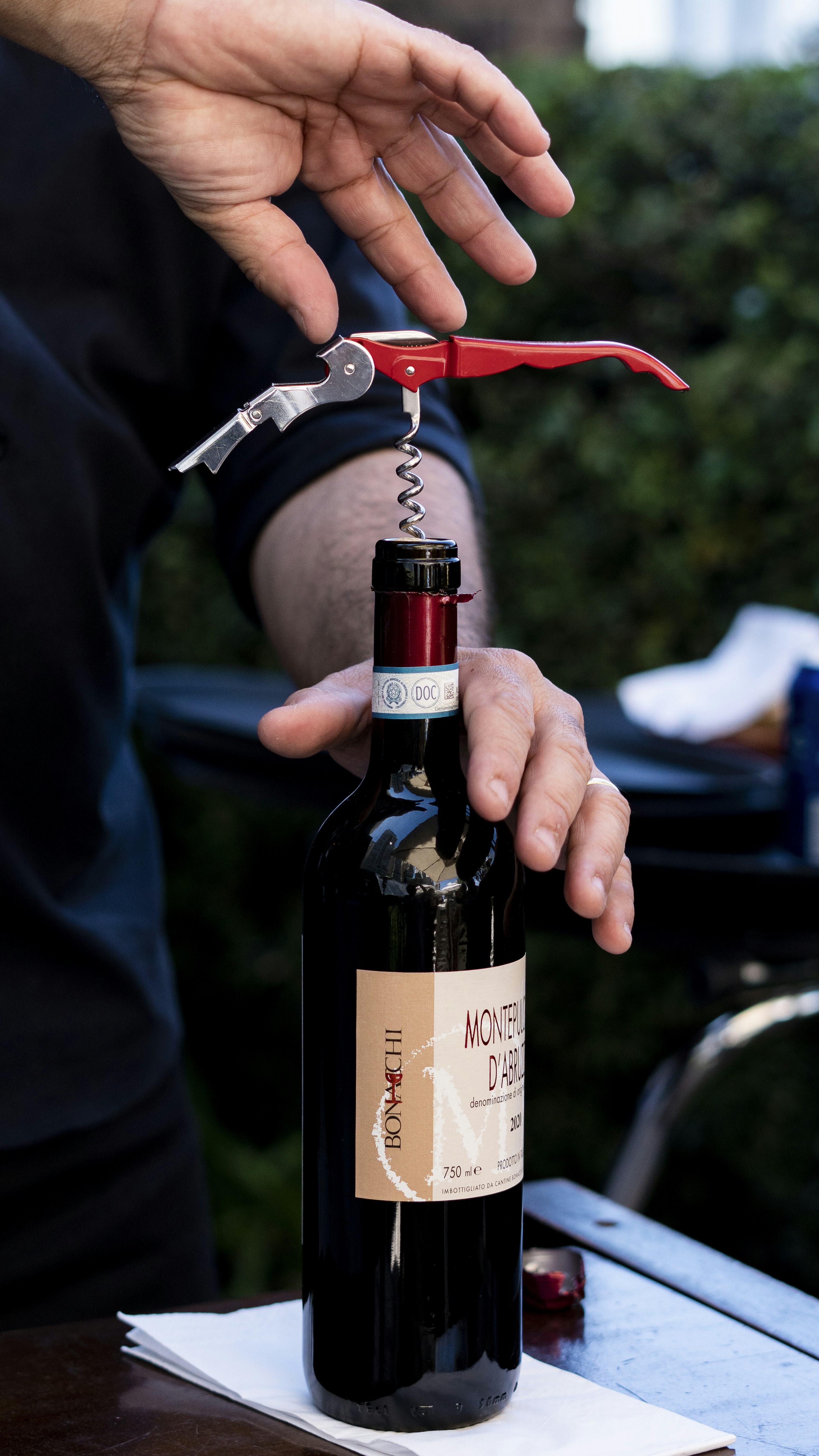 Red Lever Precision: An Outdoor Uncorking Moment