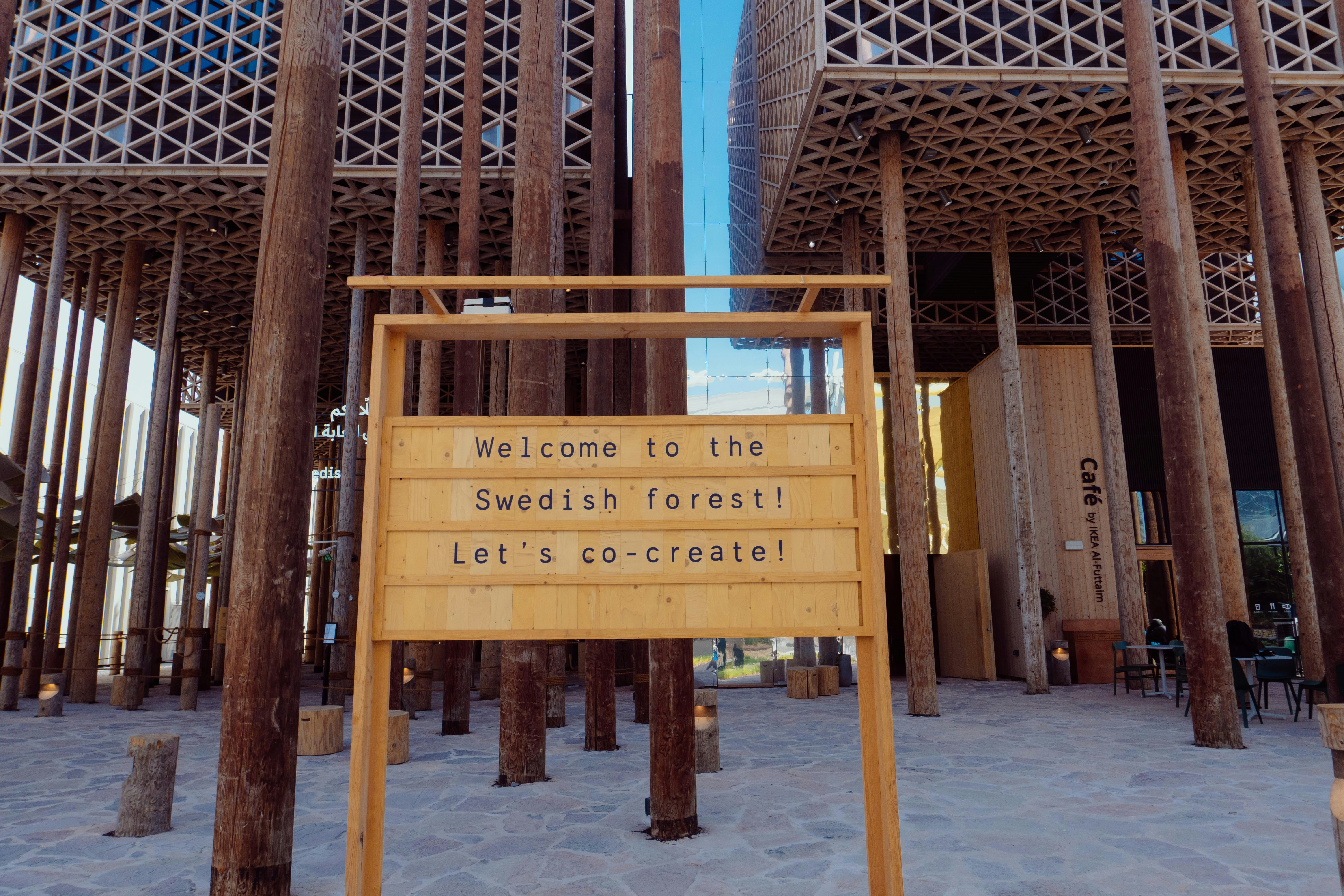 Timber Welcome: A Nordic Forest Entrance Framed by Immense Wooden Columns