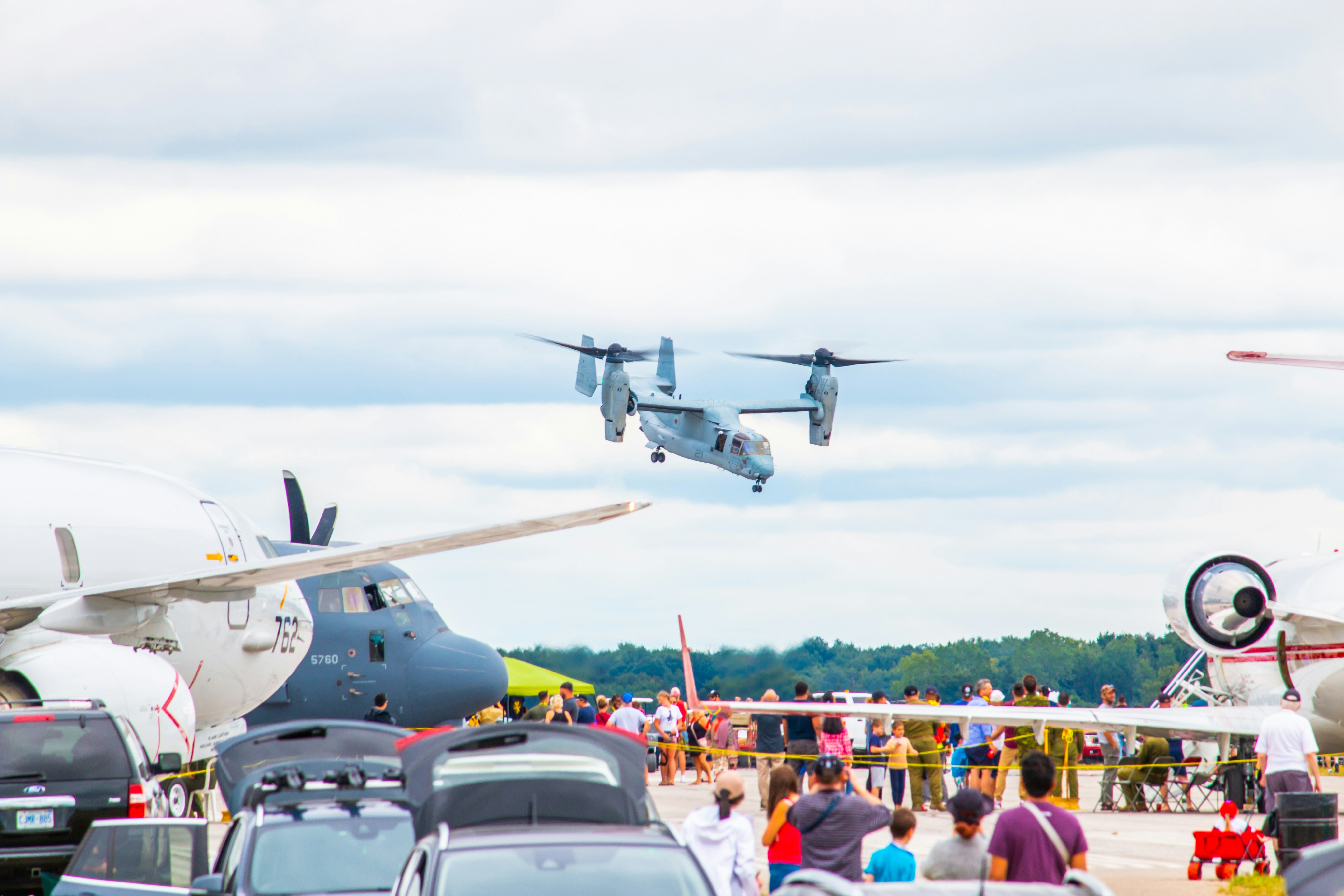 a plane flying over a crowd of people