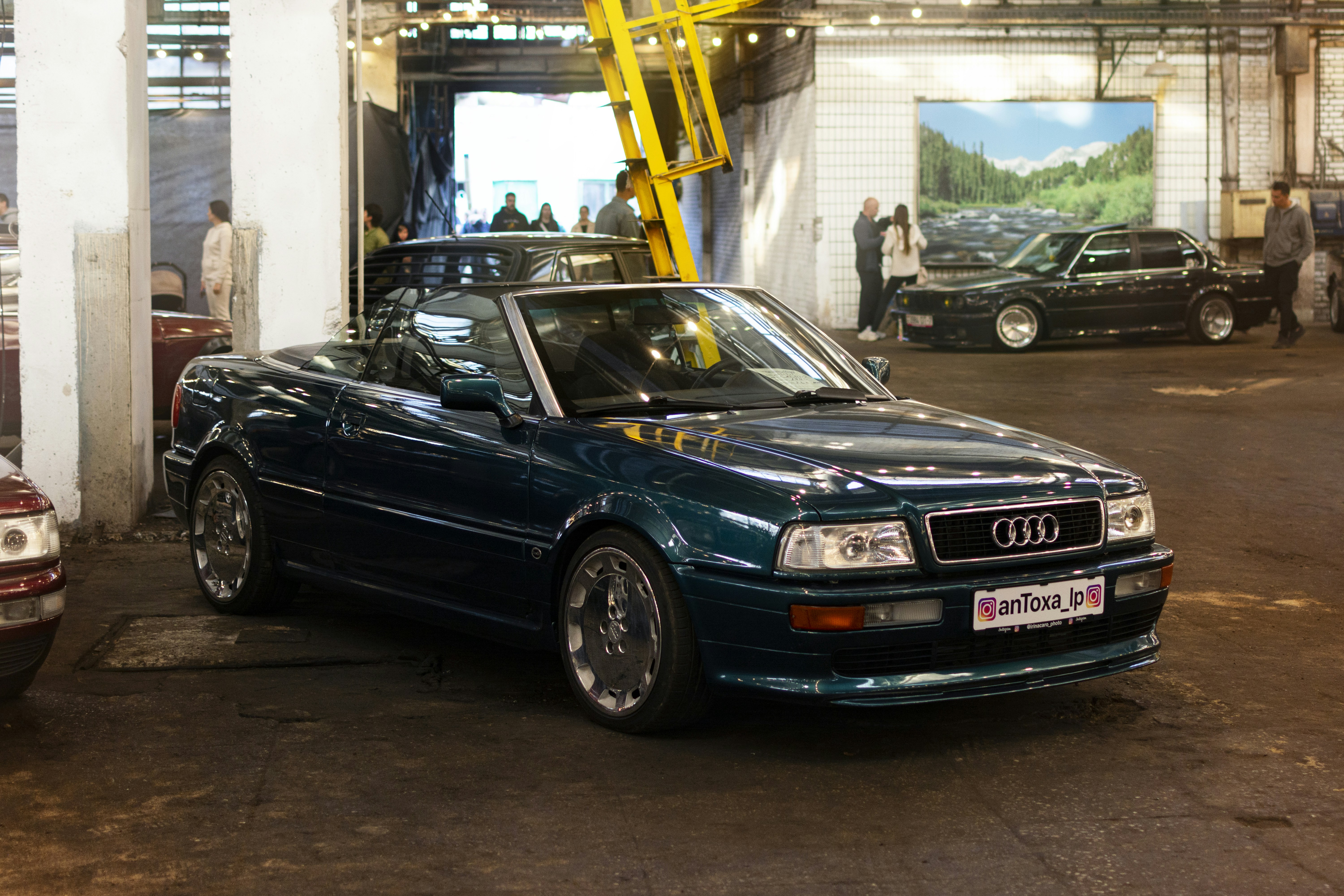 Teal Audi Cabriolet in an industrial showroom
