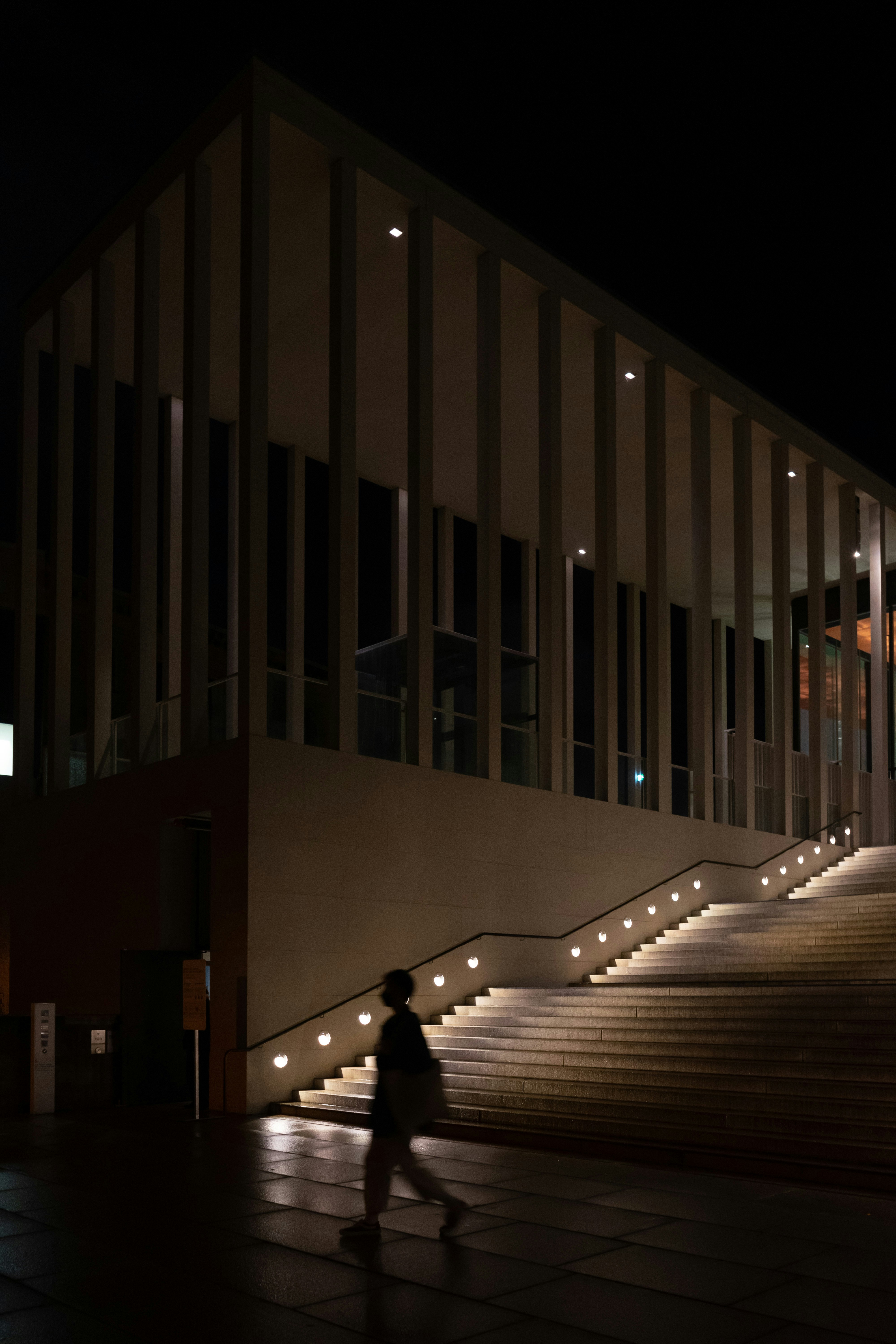 A person walking up a staircase photo – Free Berlin Image on Unsplash