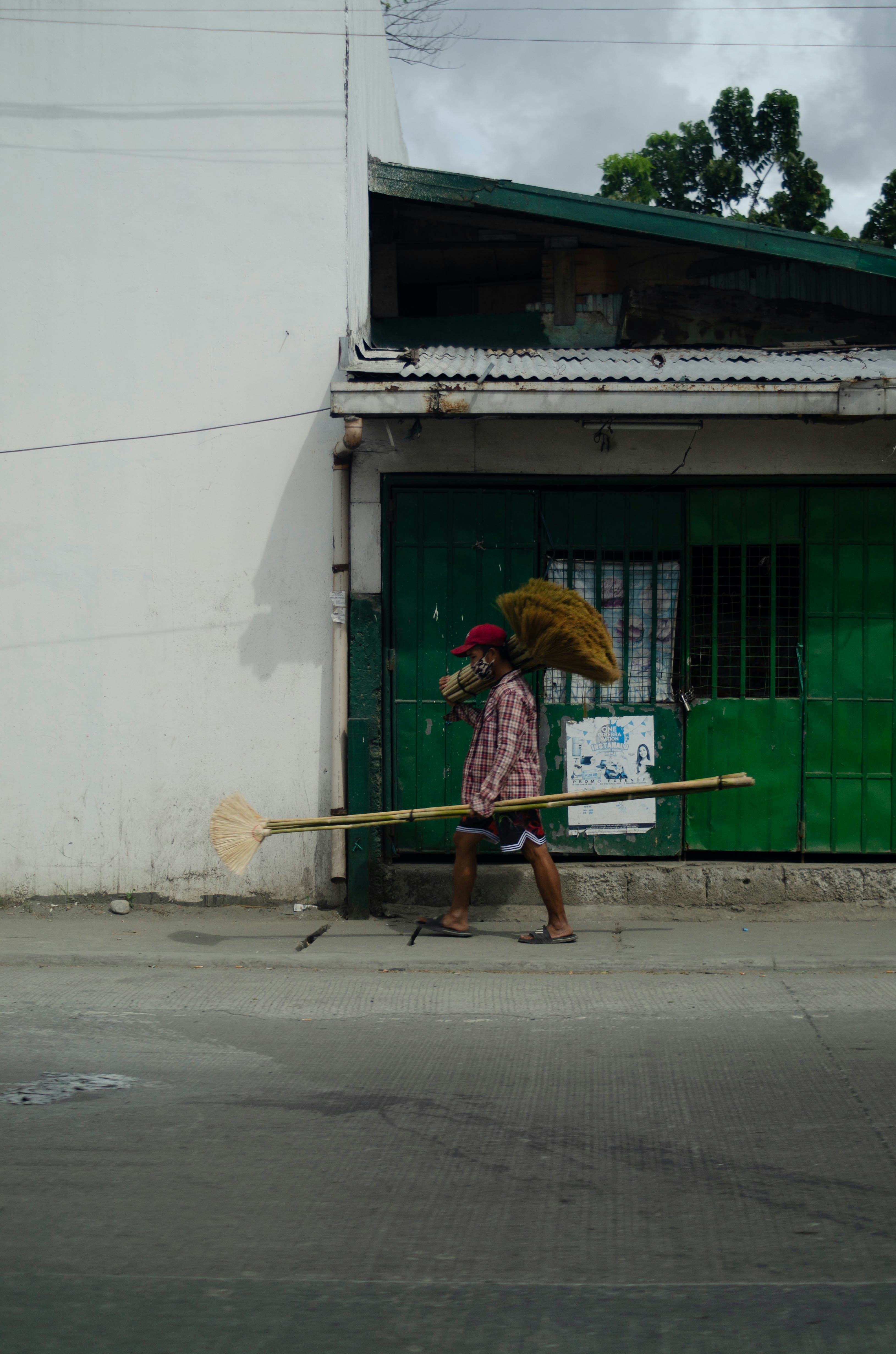 A person carrying a broom photo – Free Street Image on Unsplash