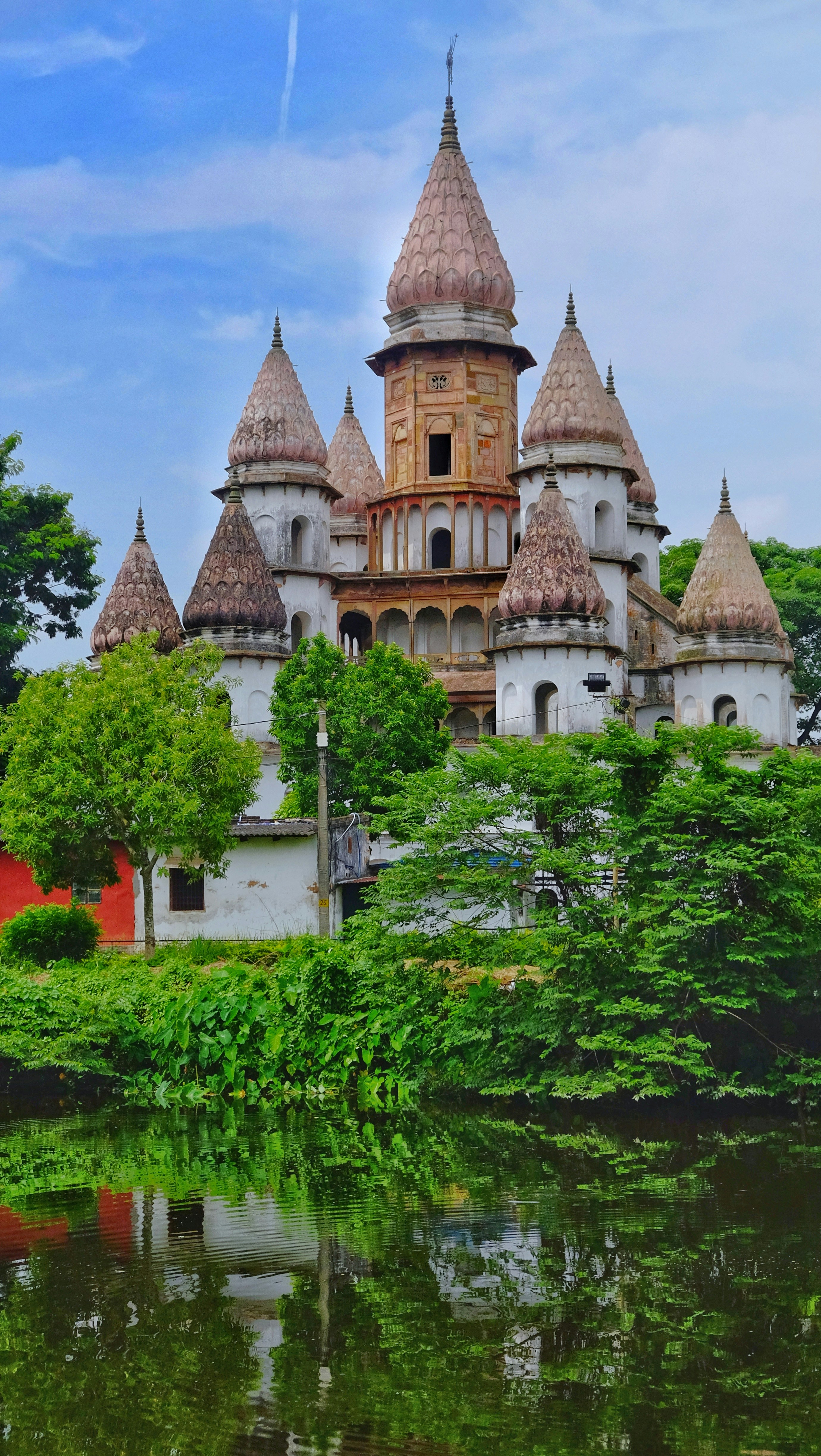 A castle with pointy roofs by a body of water photo – Free India Image ...