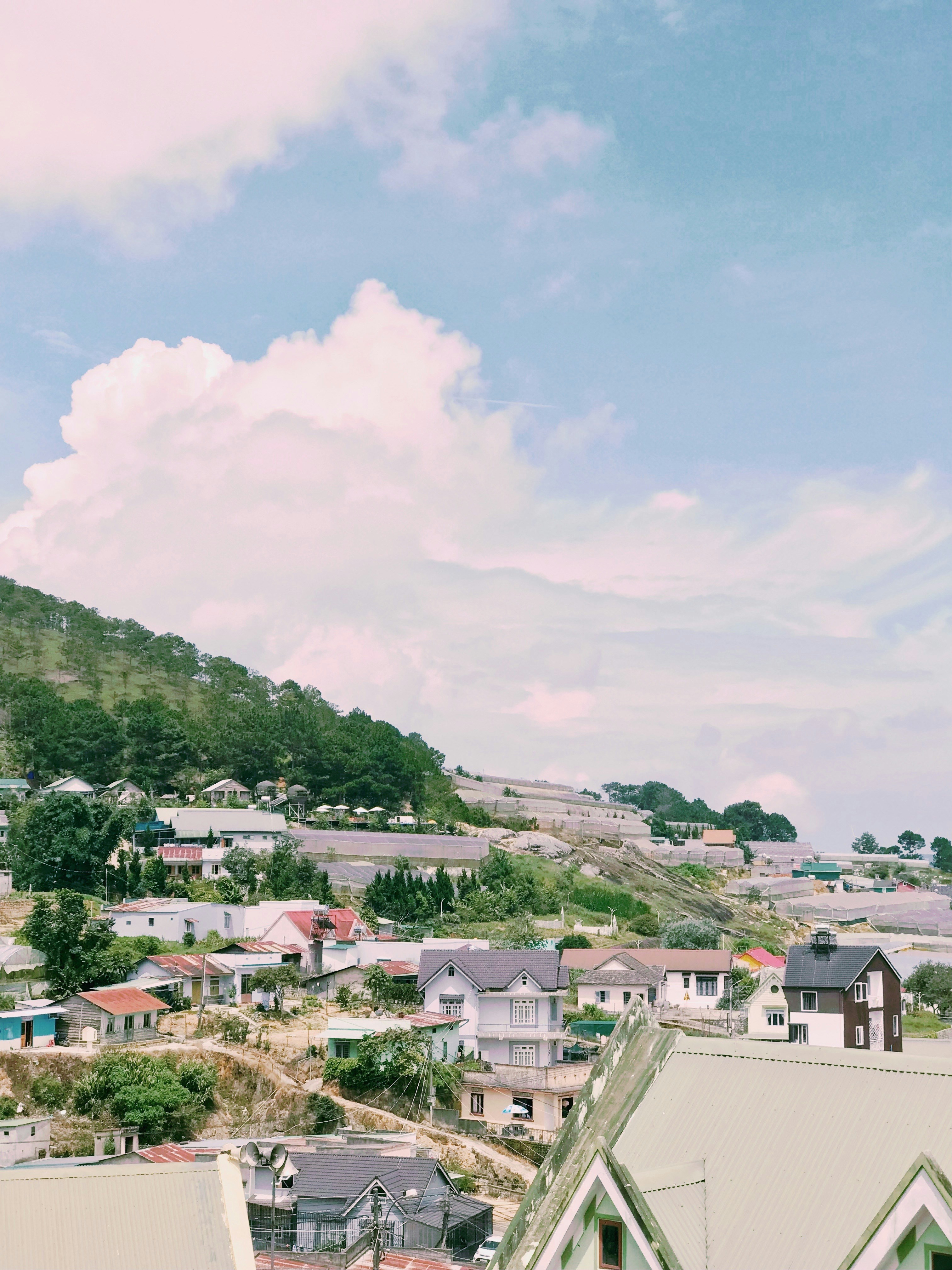 Pastel Rooftops on a Hillside Village Beneath a Quiet Sky