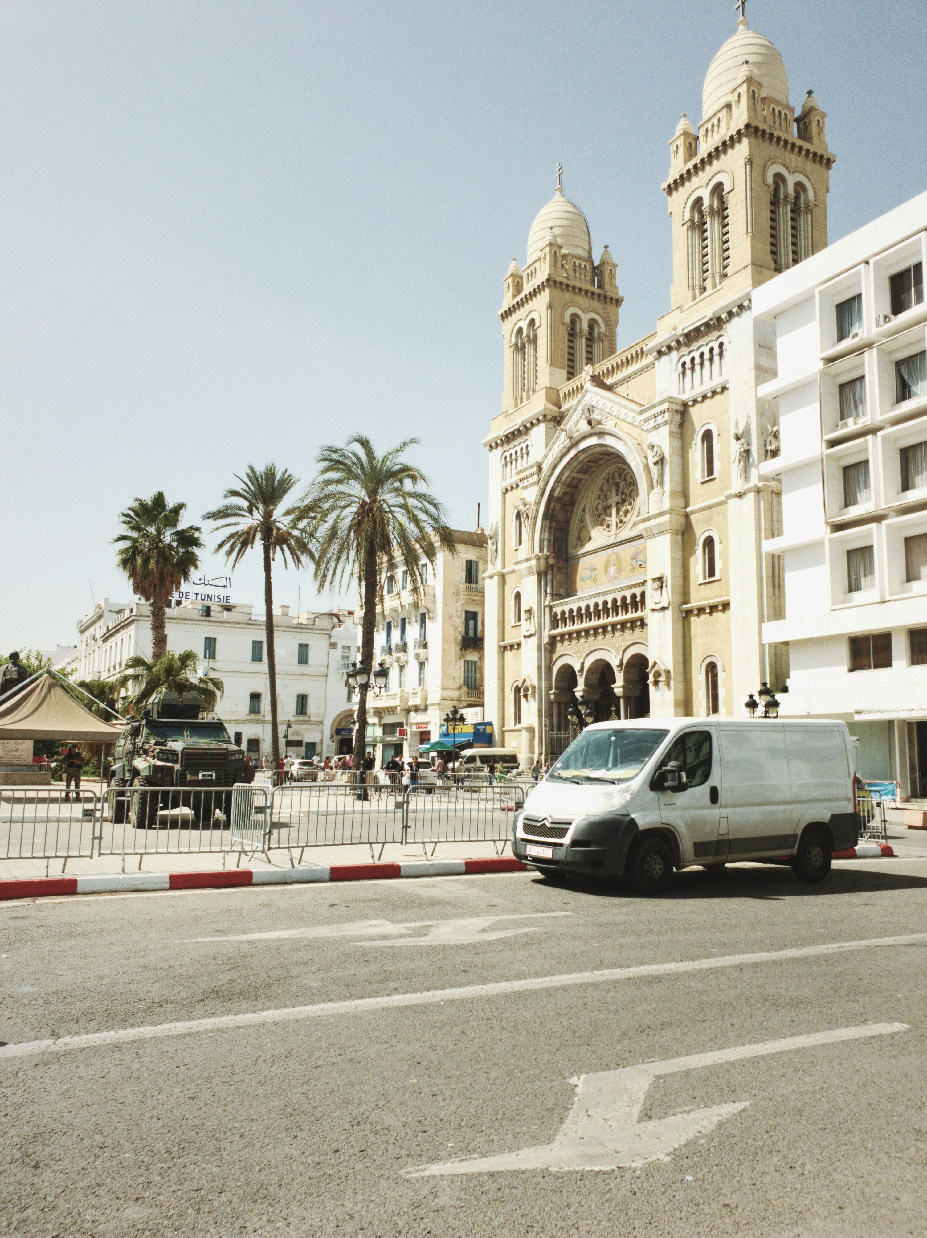 Twin-Tower Cathedral Over a Palm-Lined Mediterranean Street