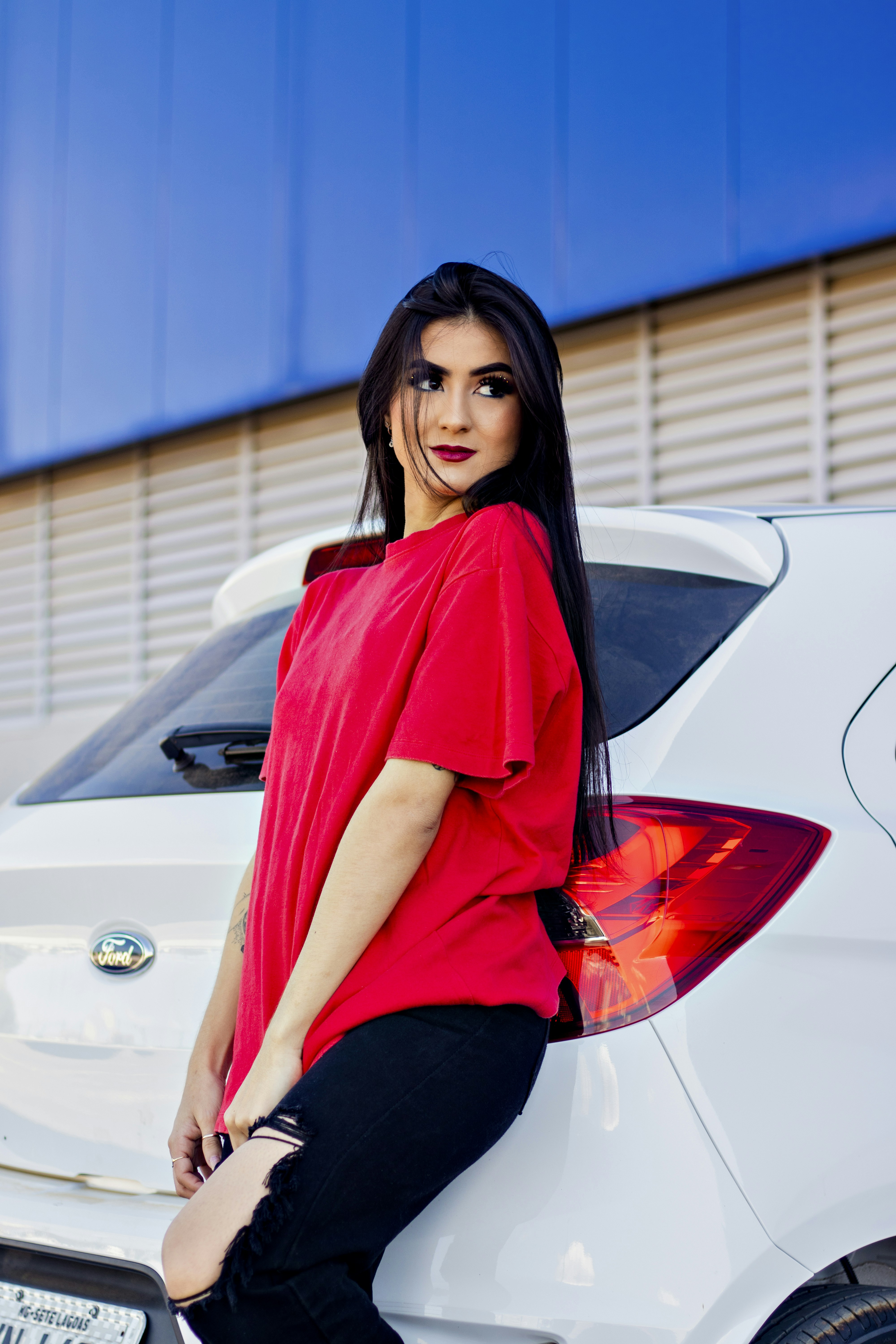 a woman sitting on a car