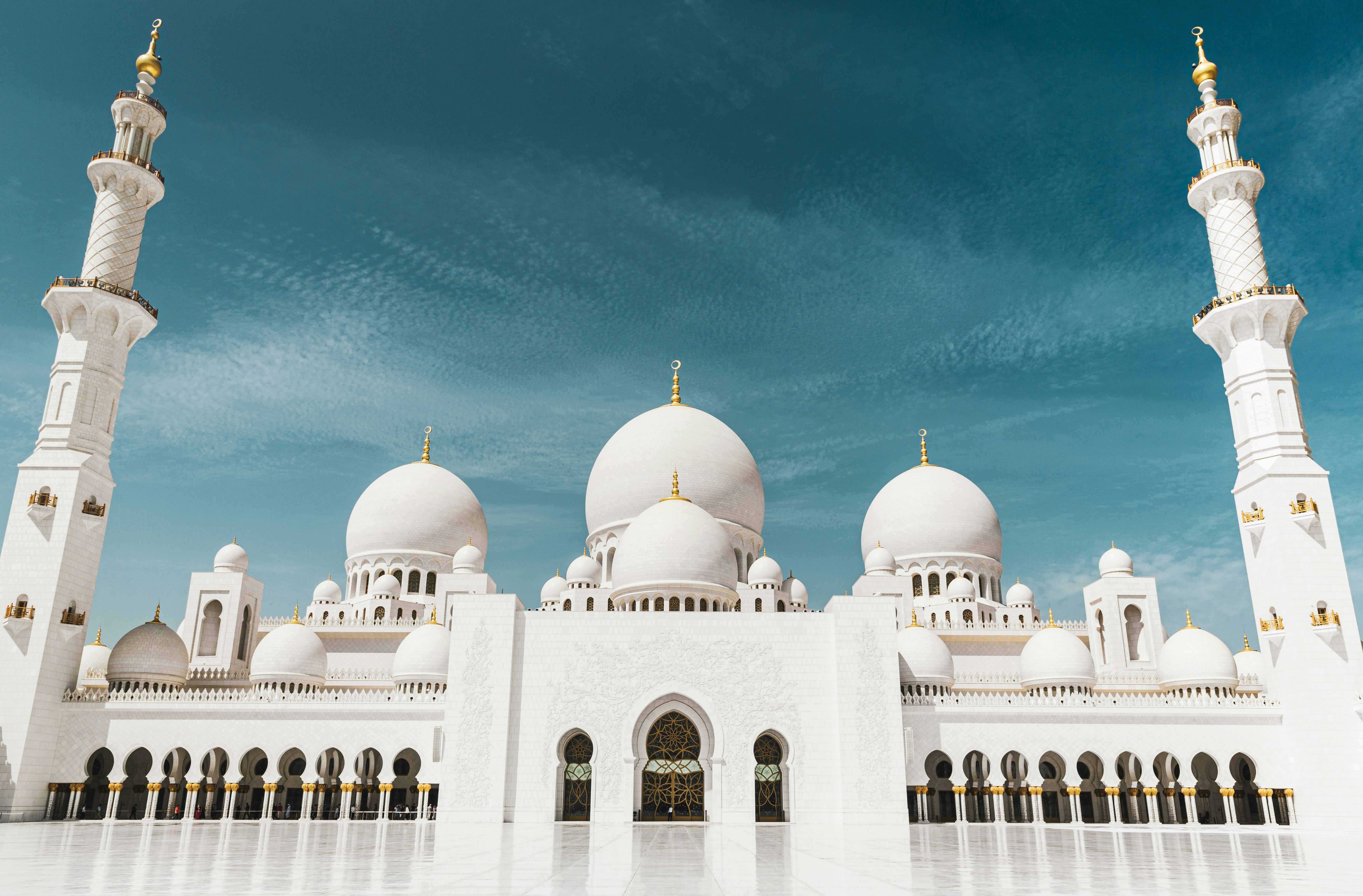 A large white building with towers with Sheikh Zayed Mosque in the ...