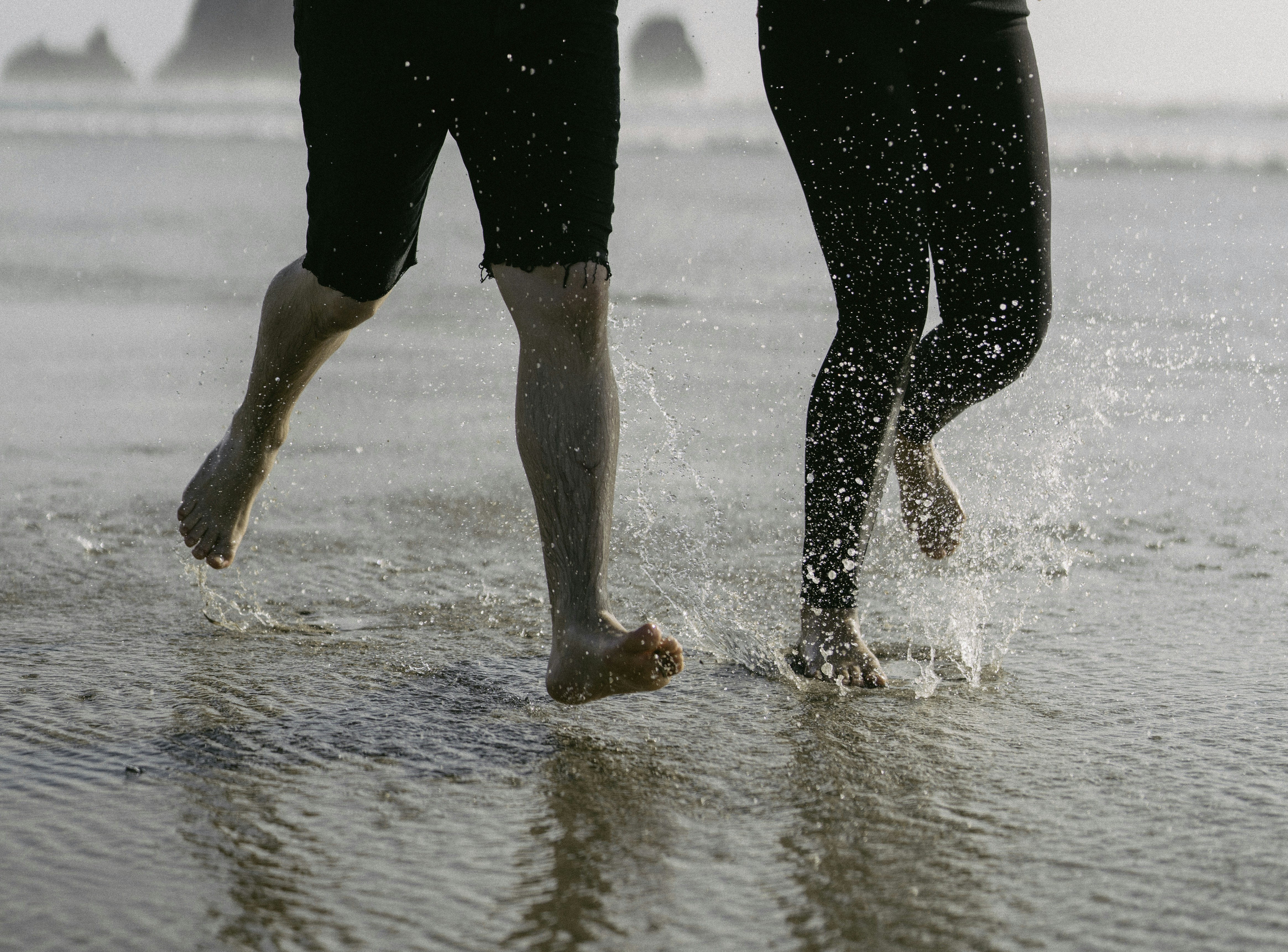 A pair of people walking in water photo – Free Grey Image on Unsplash