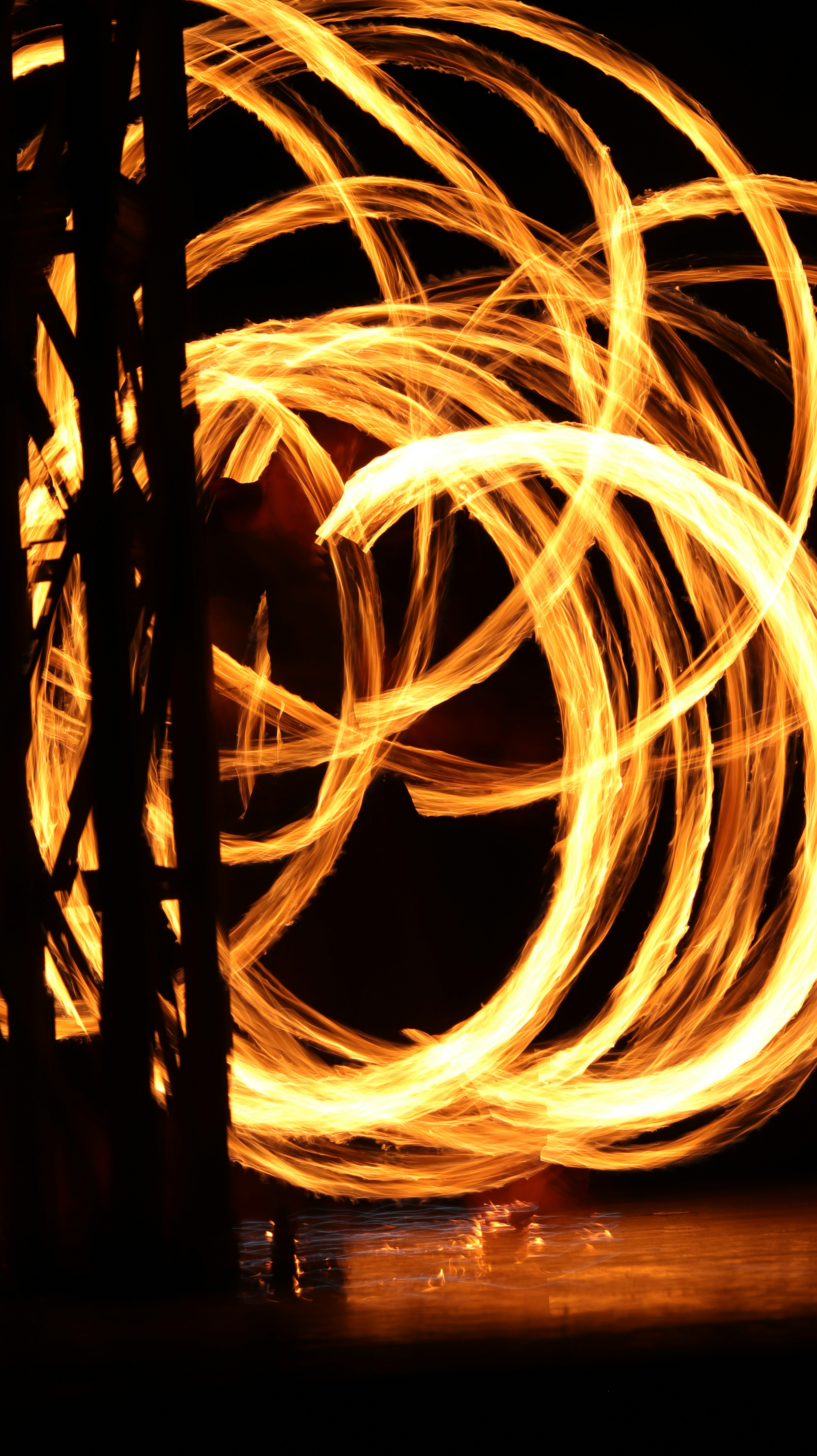 Orbital Fire Loops Encircle a Silent Silhouette