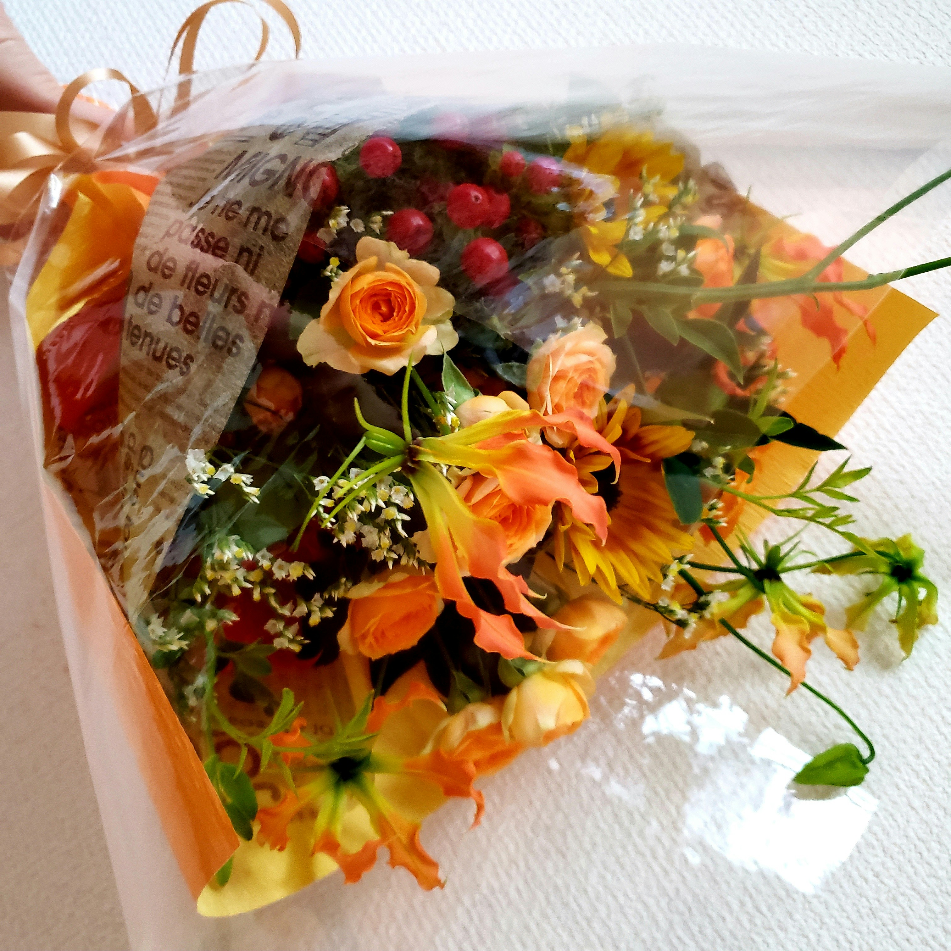 Bouquet of Warmth: A Burst of Orange Blooms Wrapped in Paper and Ribbon