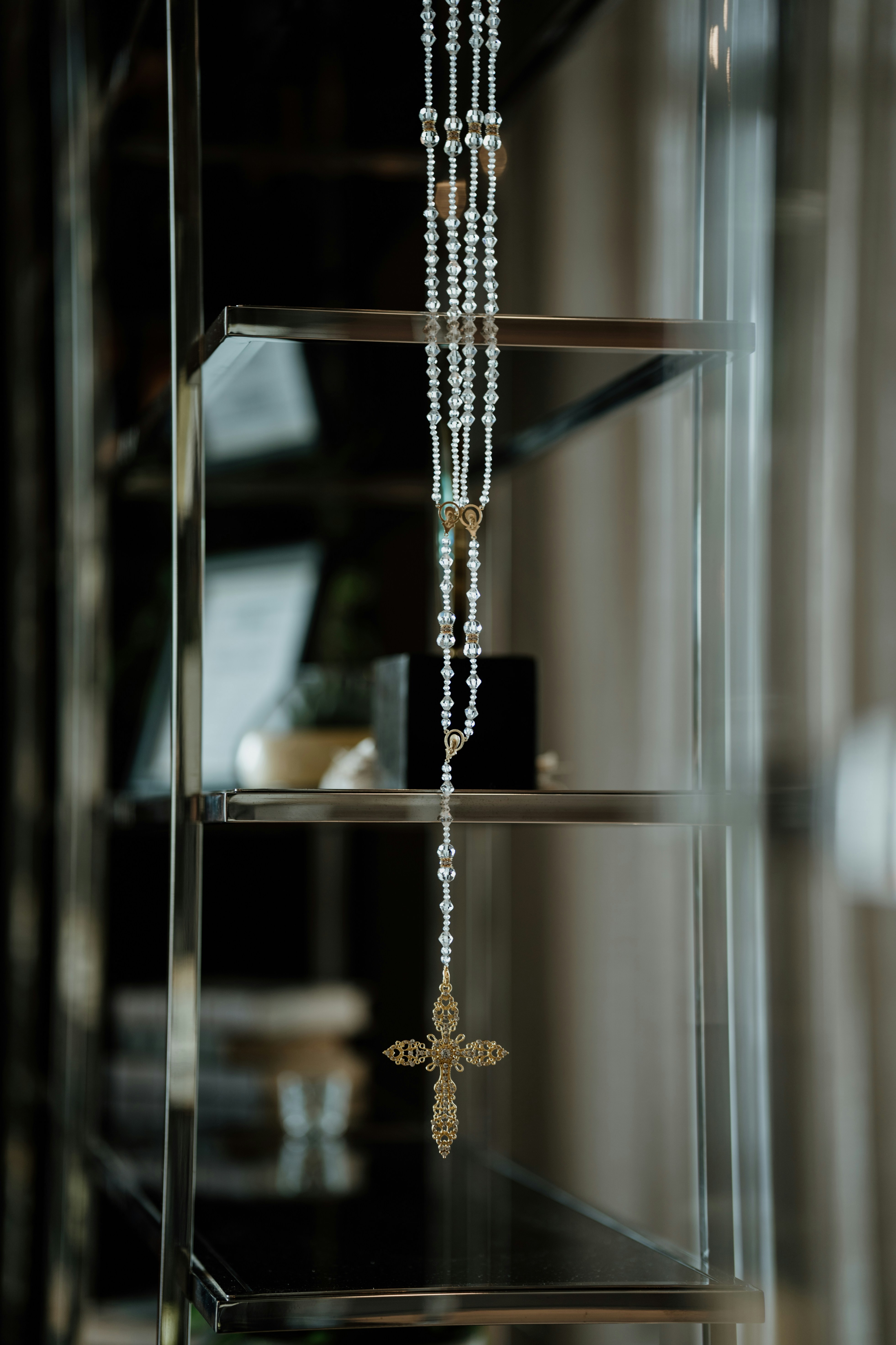 Cruciform Necklace Reverie in a Glass Display