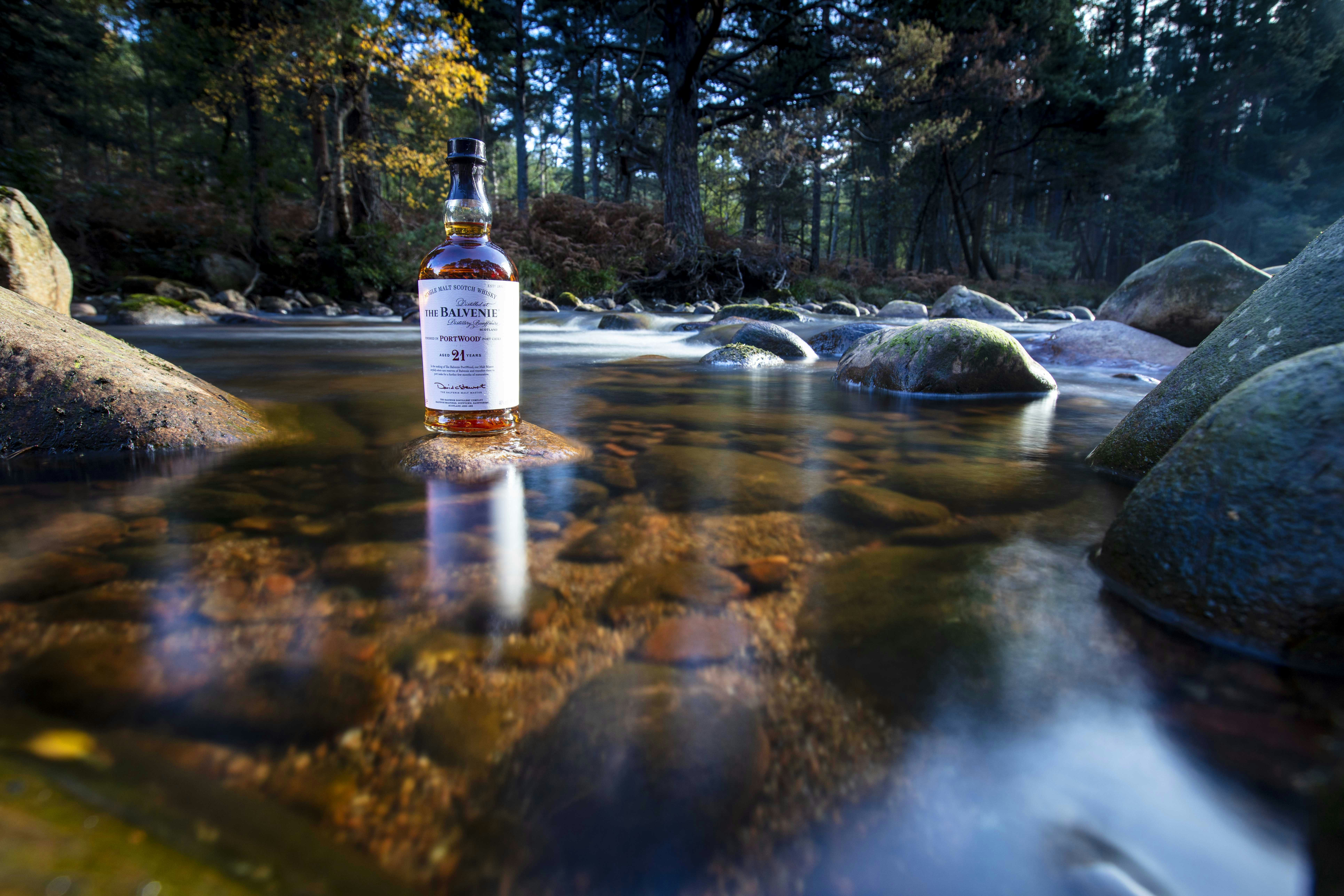 A bottle of alcohol in a stream photo – Free Glen tanar Image on Unsplash