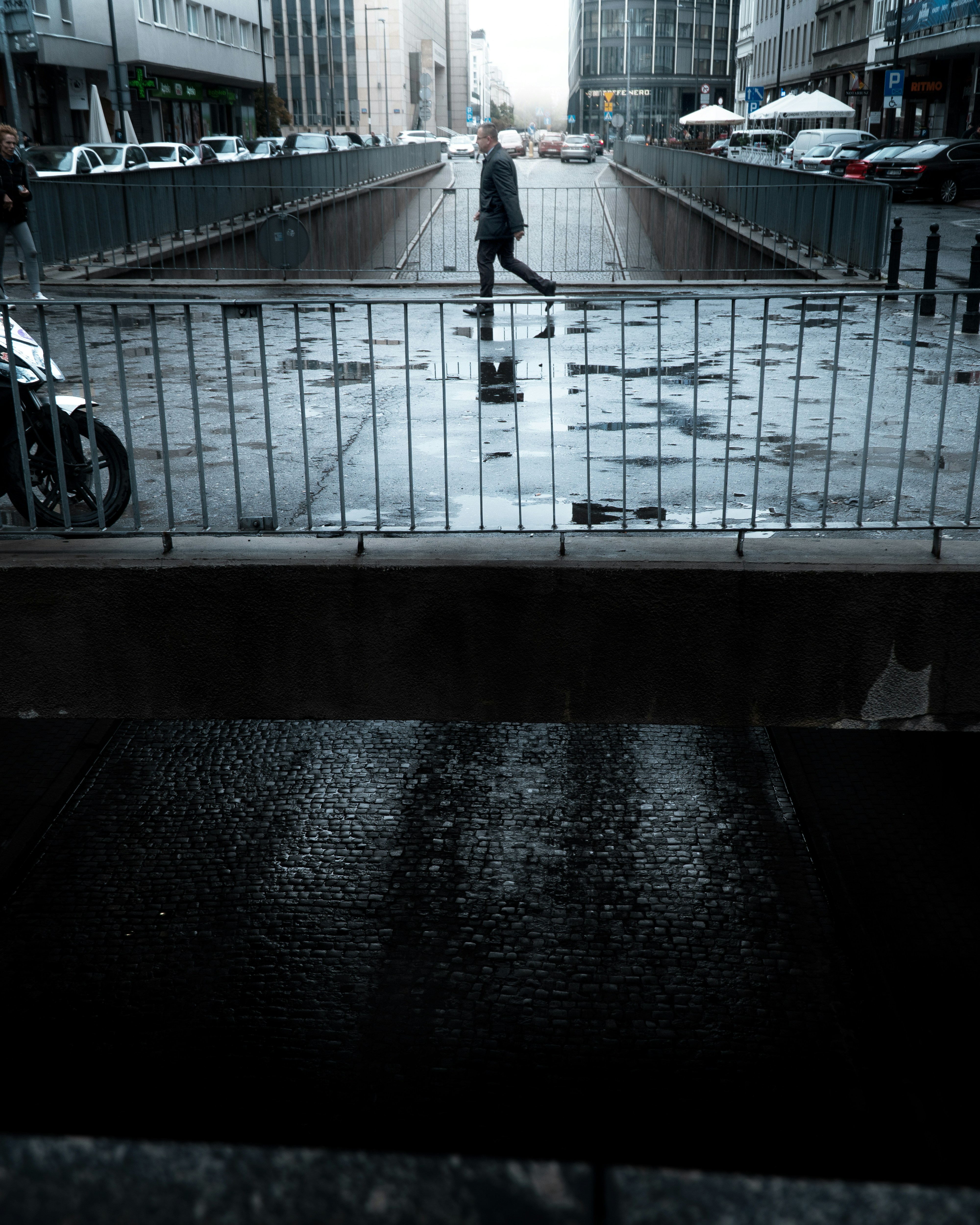 Footstep Through Reflections: A Solitary Crossing on a Rain-Washed City Street