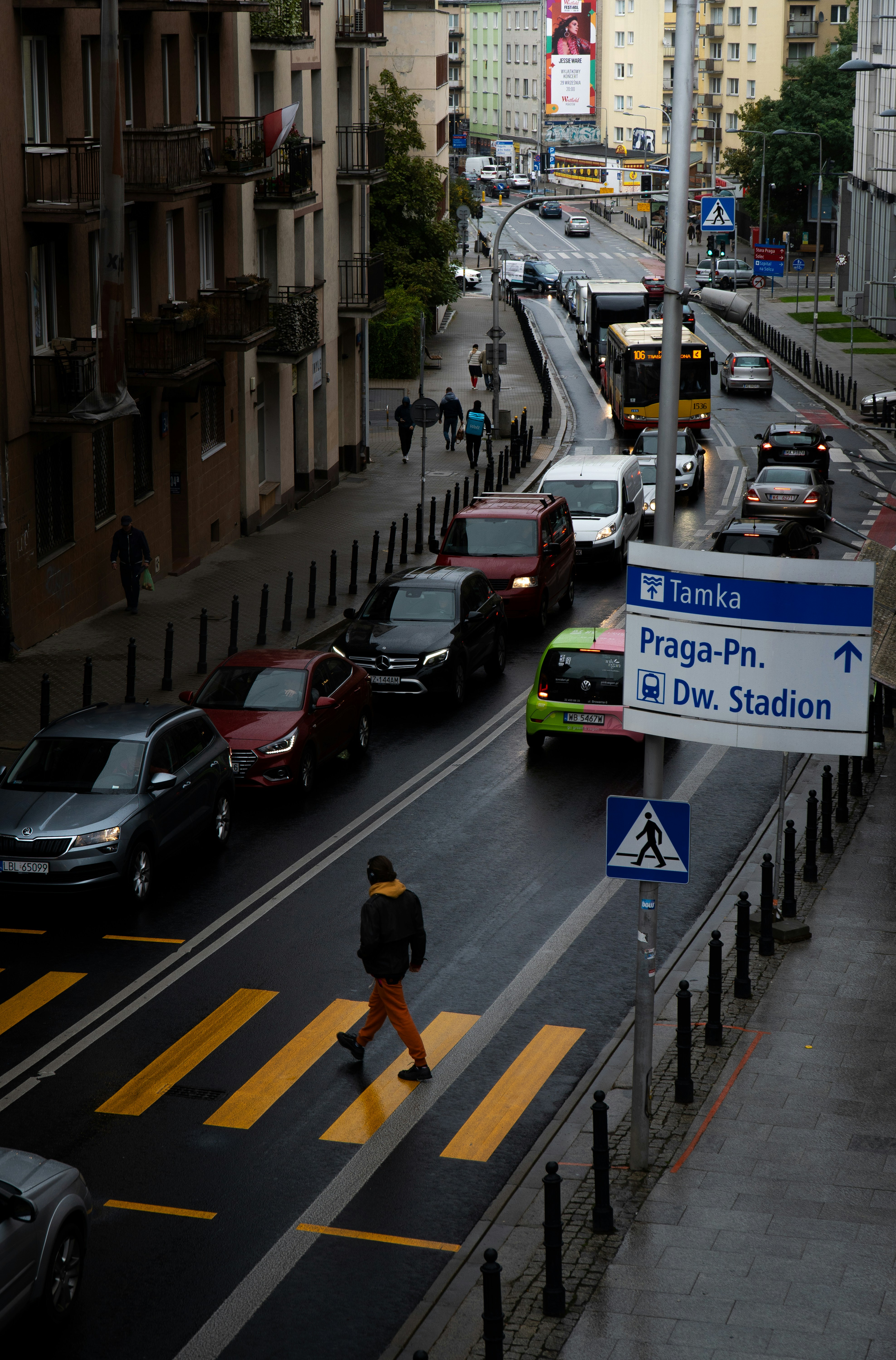 Orange-Trousers Crossing Through Prague Street Traffic