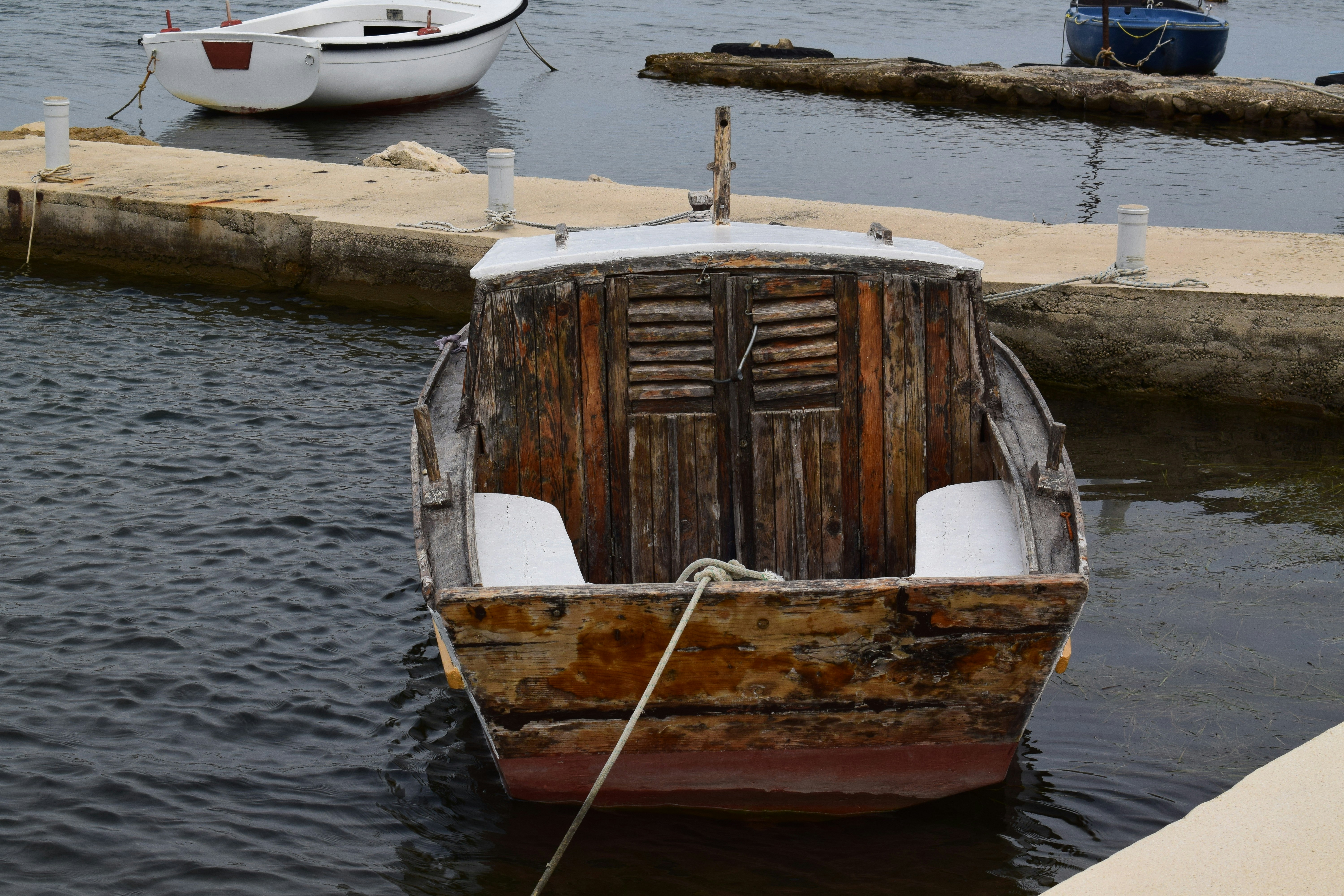 Beautiful old boat. | a boat tied to a dock