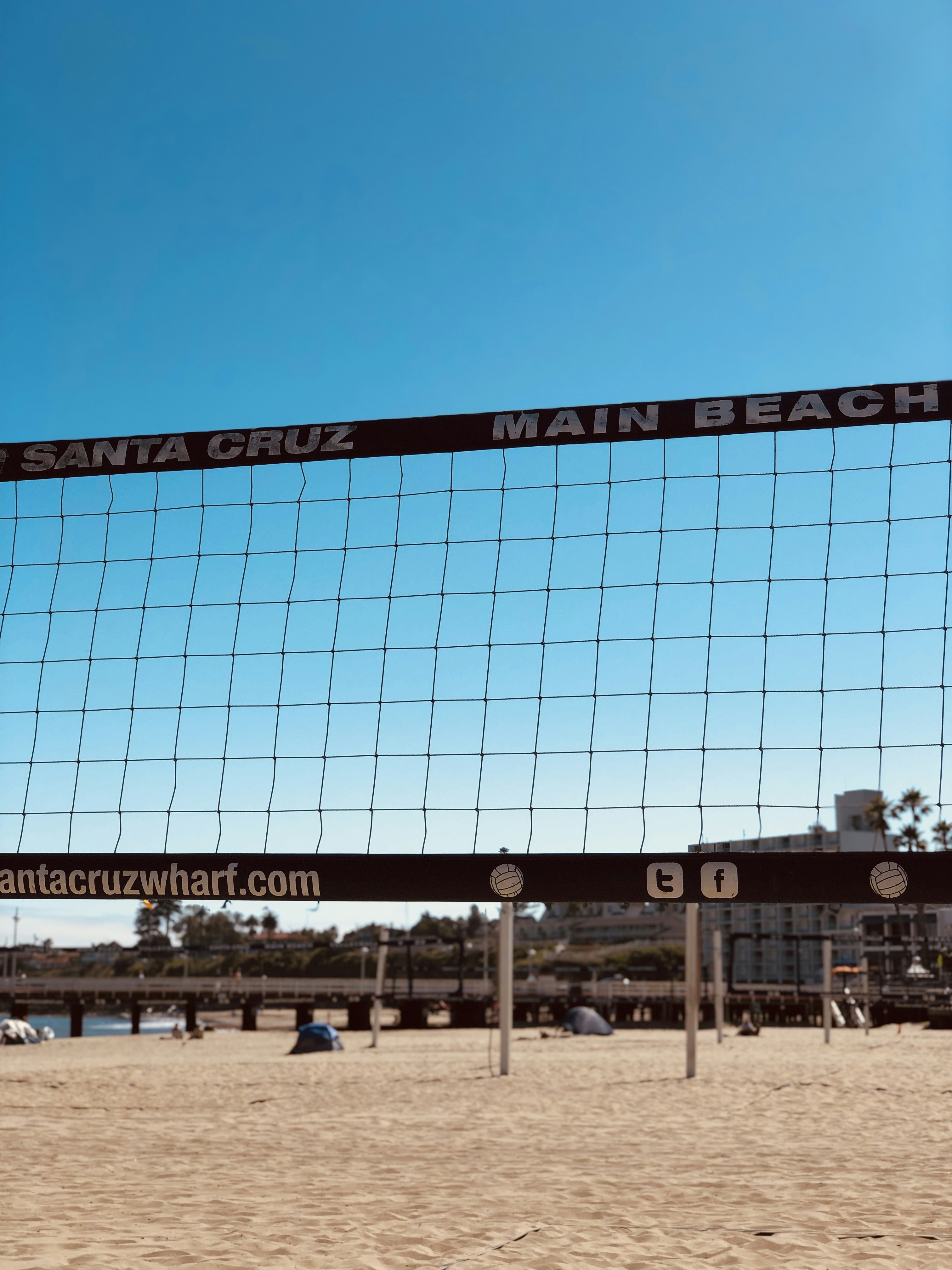 Gridlines Over Golden Sand: Santa Cruz Main Beach Volleyball Net
