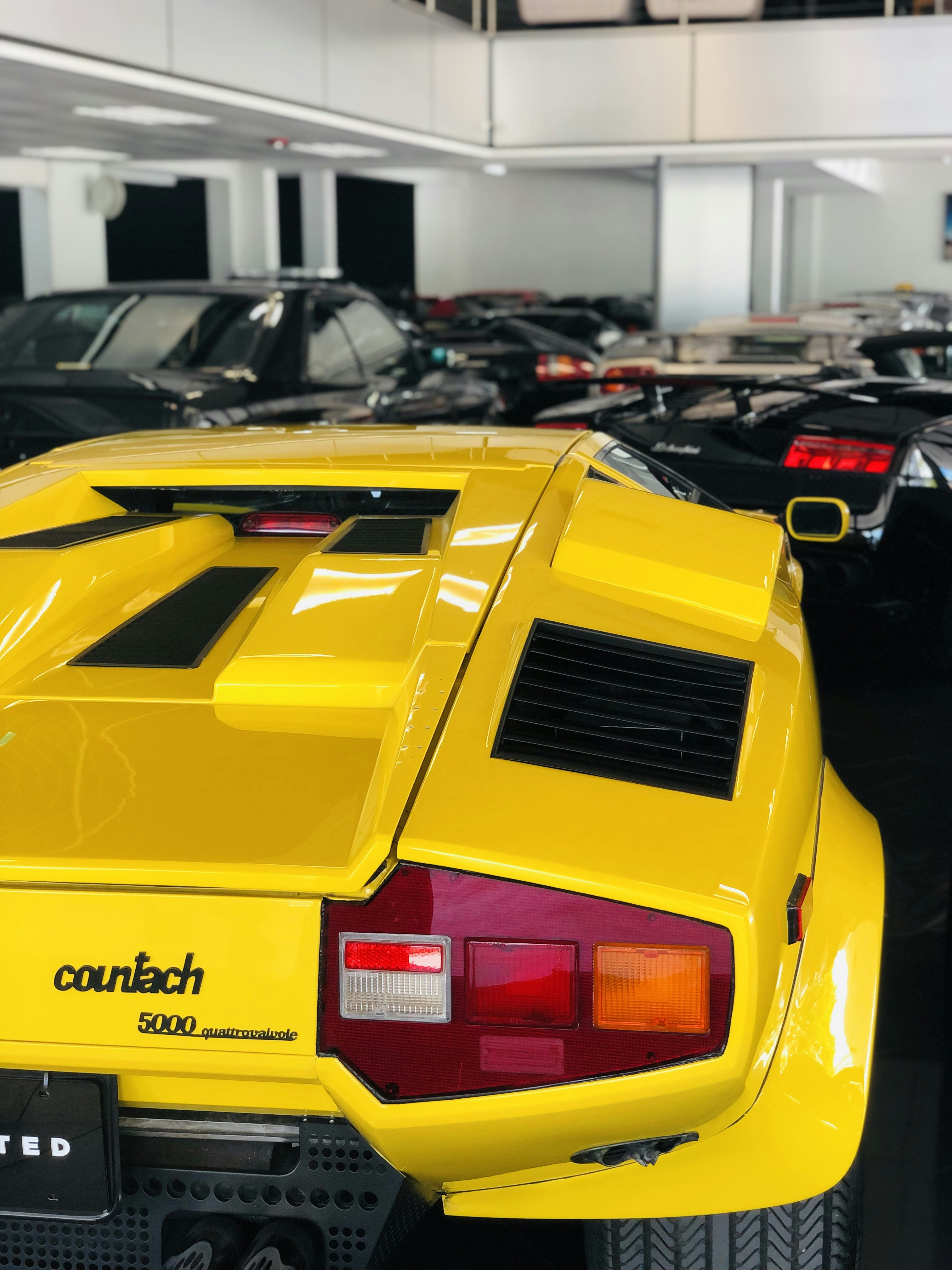 A yellow car parked in a parking lot photo – Free Miami Image on Unsplash