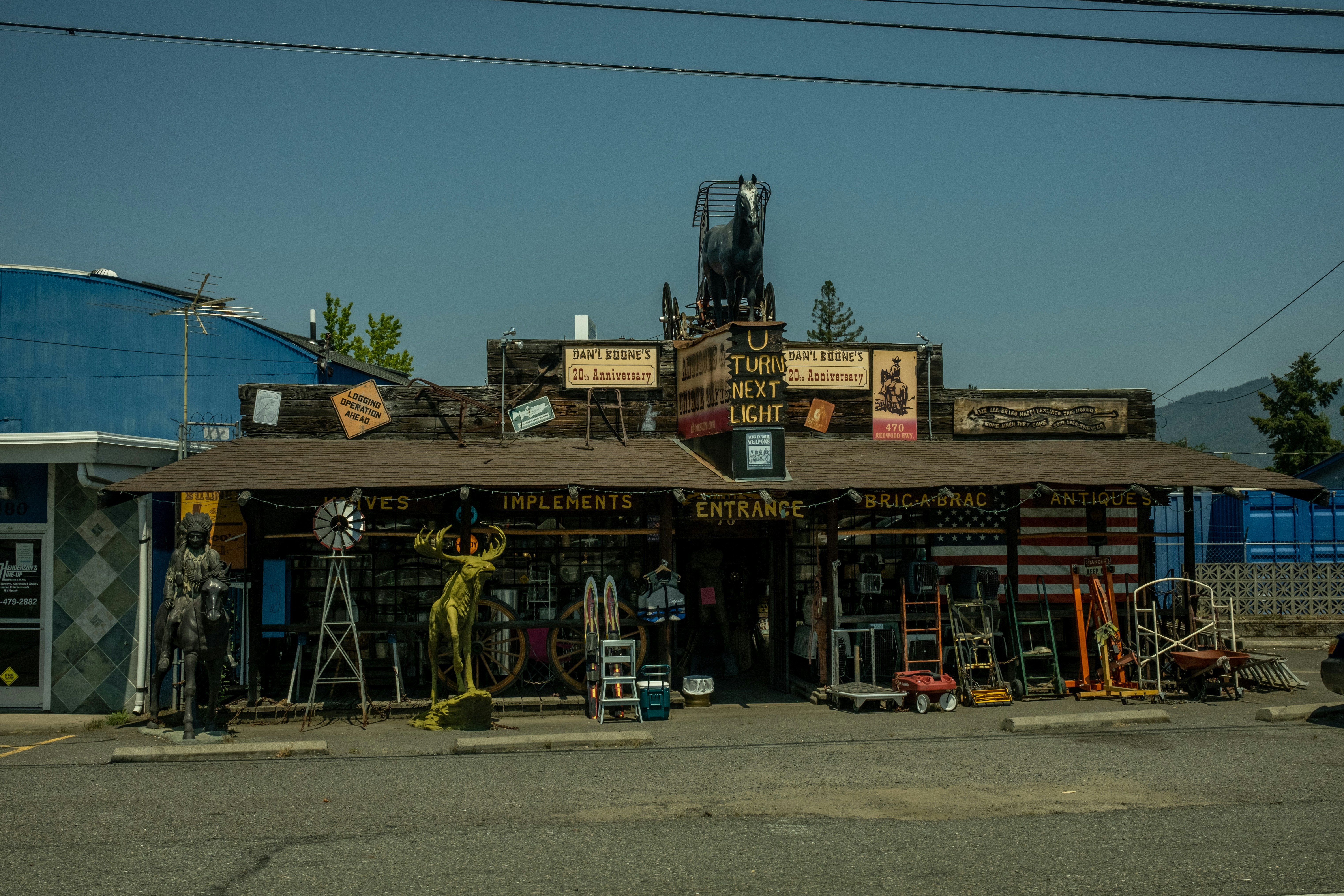 Roadside Curiosity: Weathered Facade of Signs and Sculptures