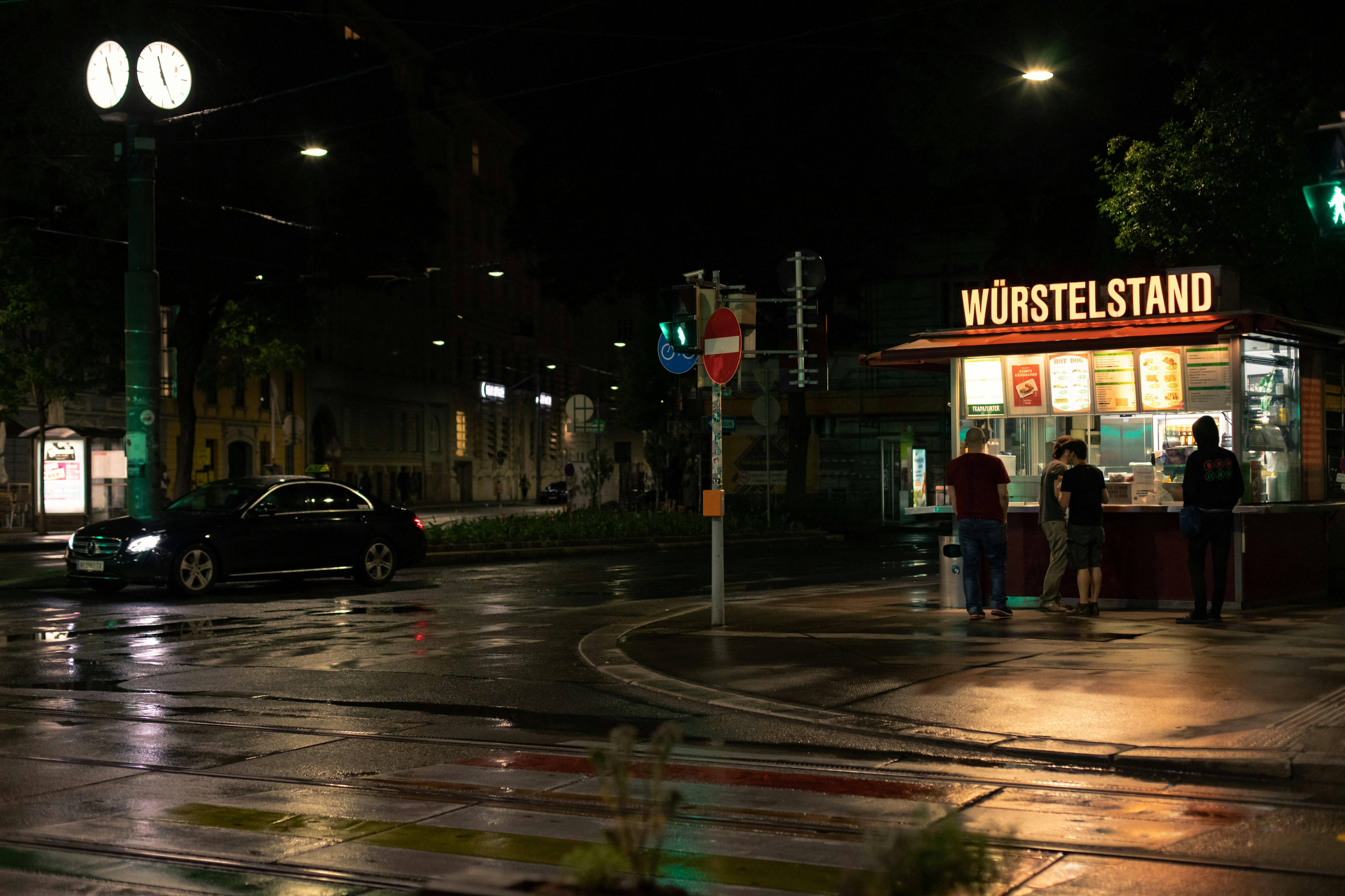 A group of people stand outside a store photo – Free Austria Image on ...
