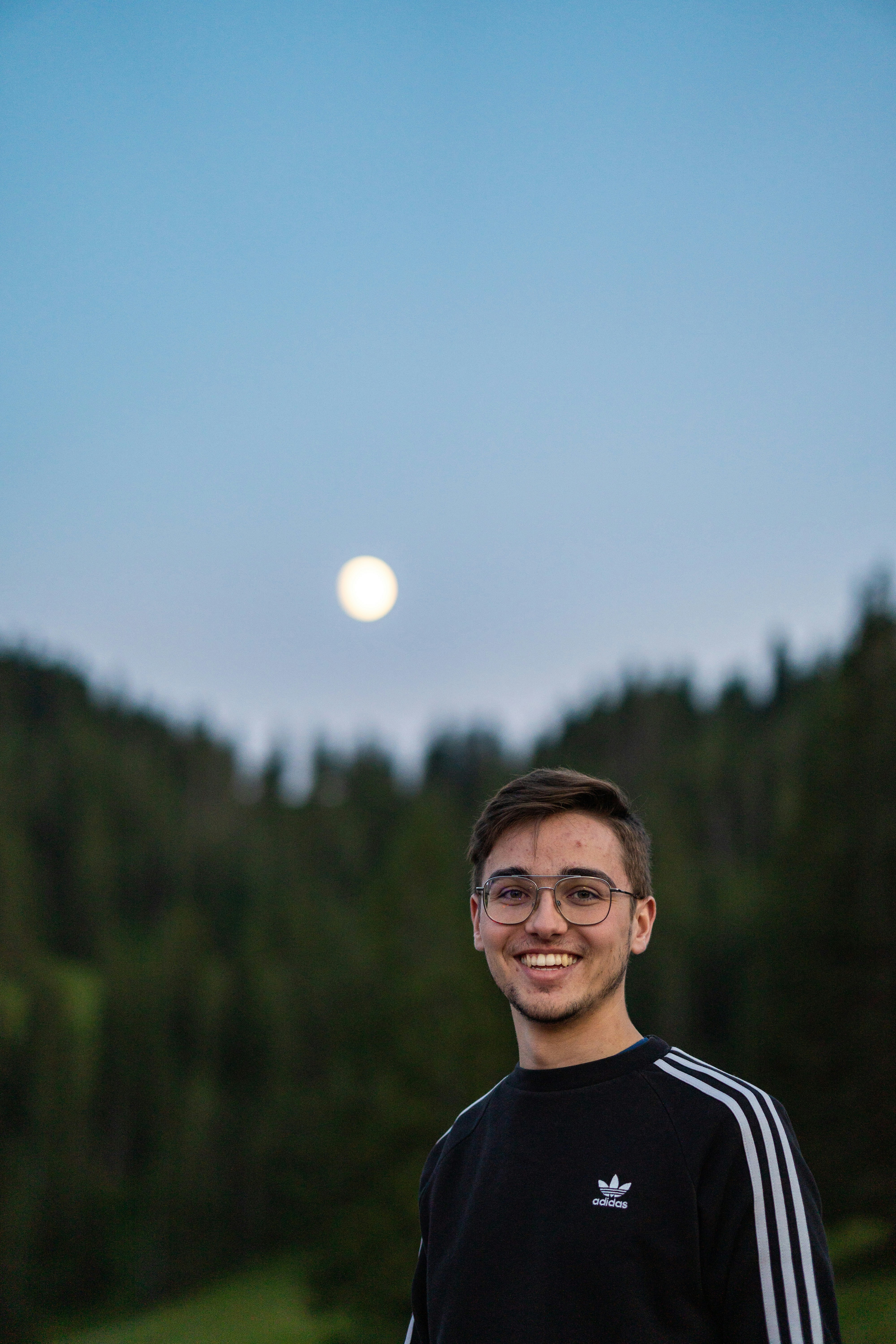 A man smiling with a moon in the background photo – Free Forest Image ...
