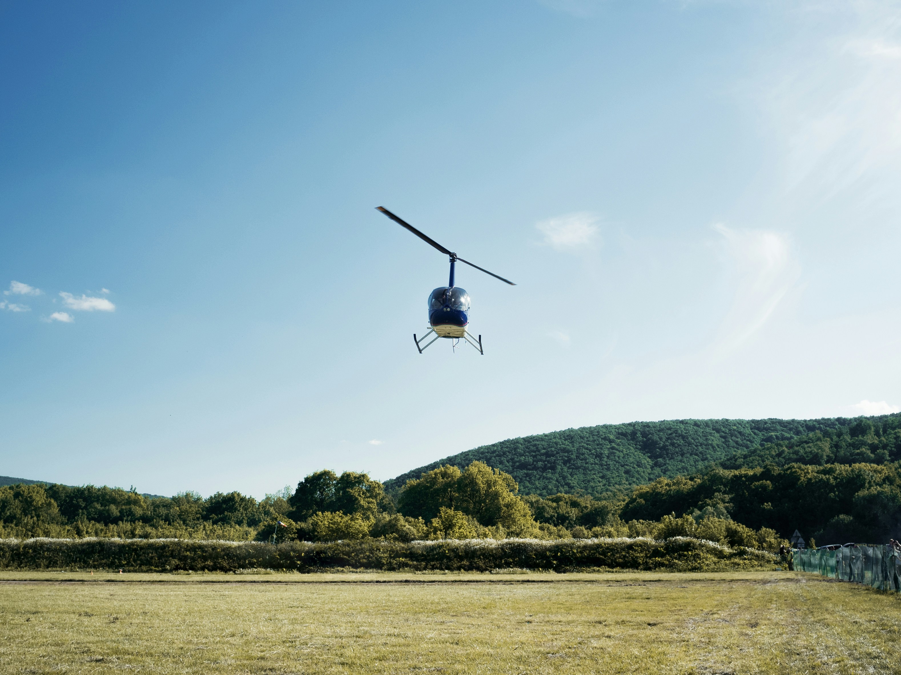 Hovering Elegance: A Helicopter in the Open Sky