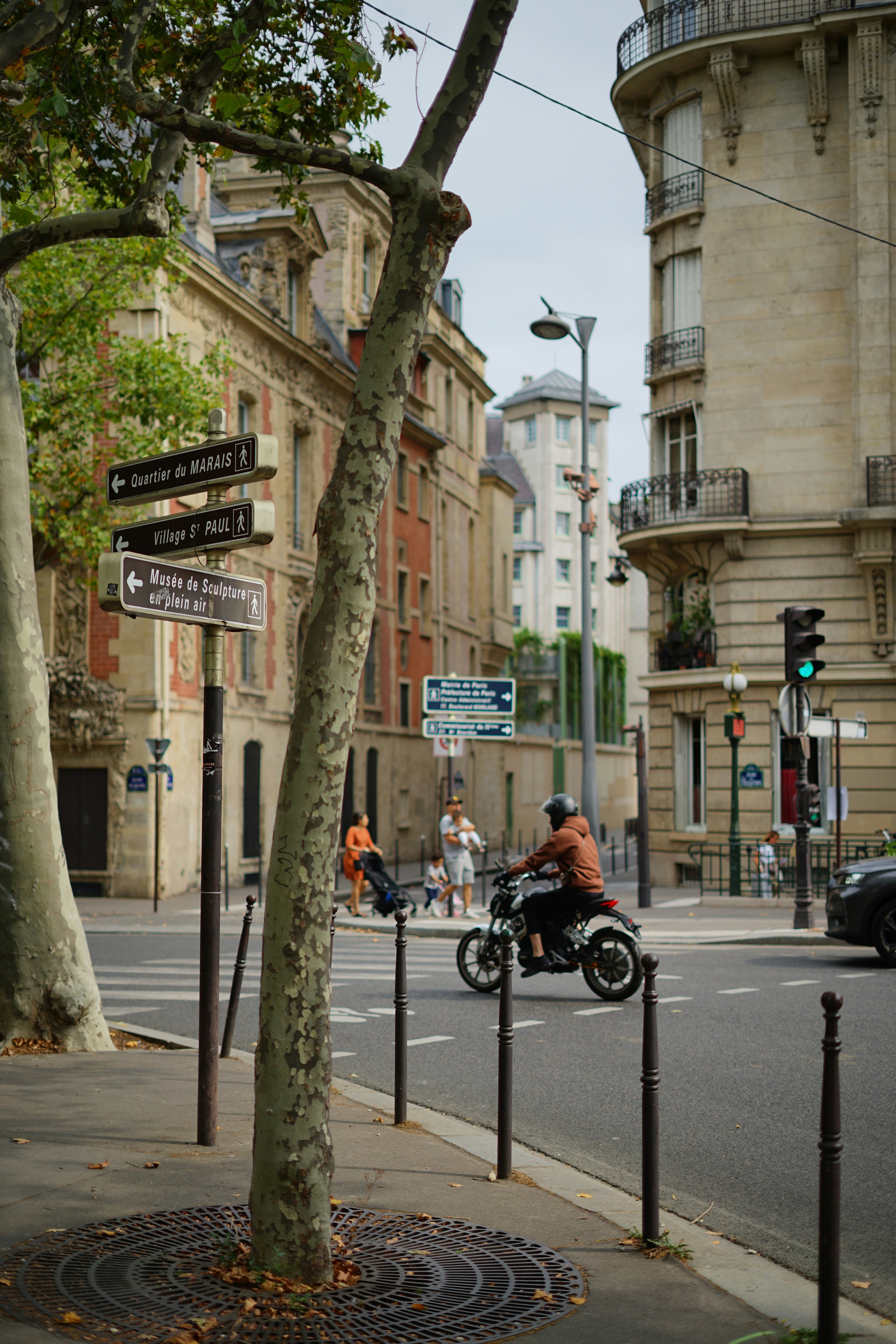 A person riding a motorcycle down a street photo – Free Paris Image on ...