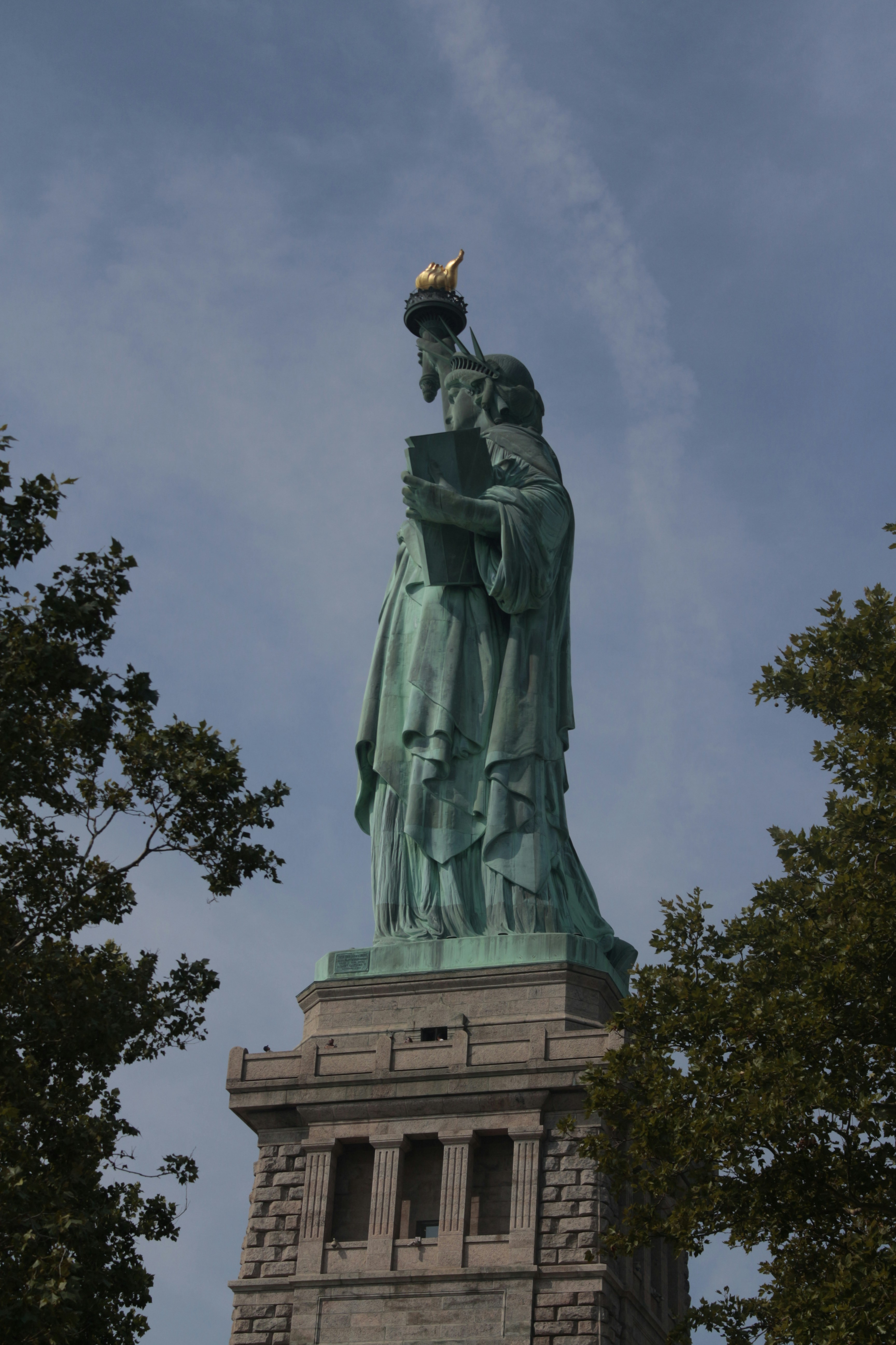 Patinaed Sentinel Under an Open Sky: A Side View of Liberty
