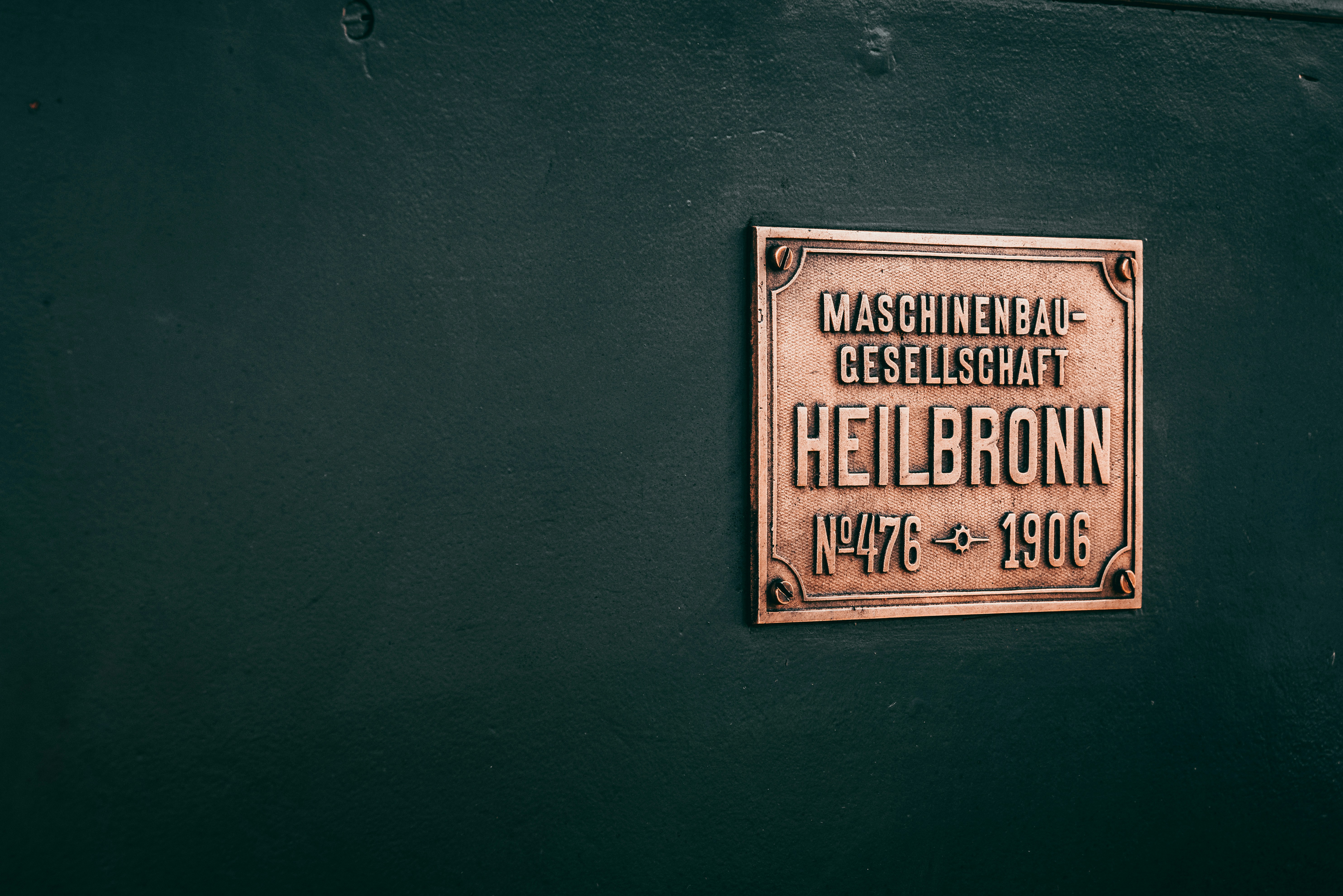 Brass plaque on a dark green steam locomotive, displaying manufacturing details.
