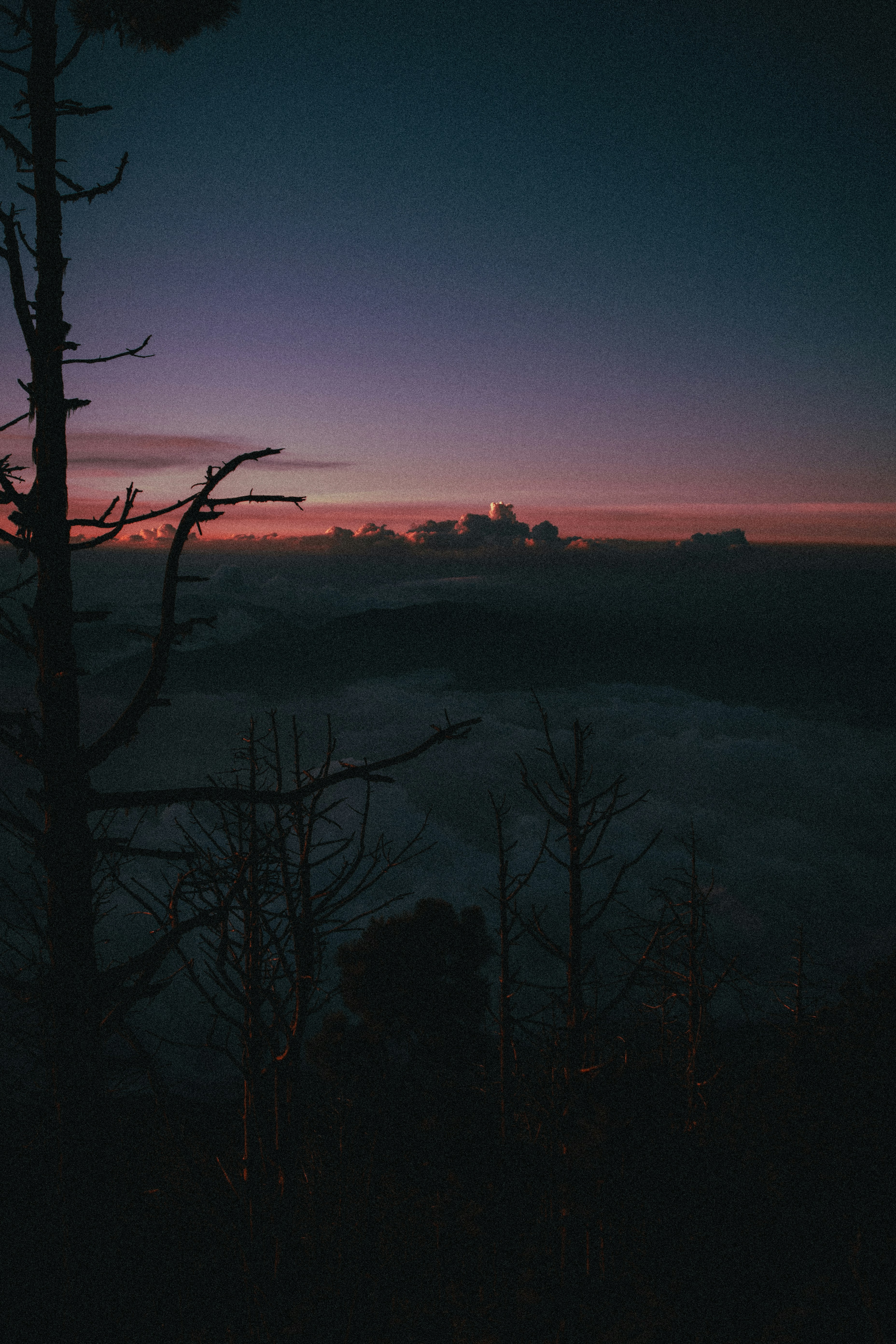 Horizon in Hush: Twilight Silhouettes Over a Cloud-Wedged Valley
