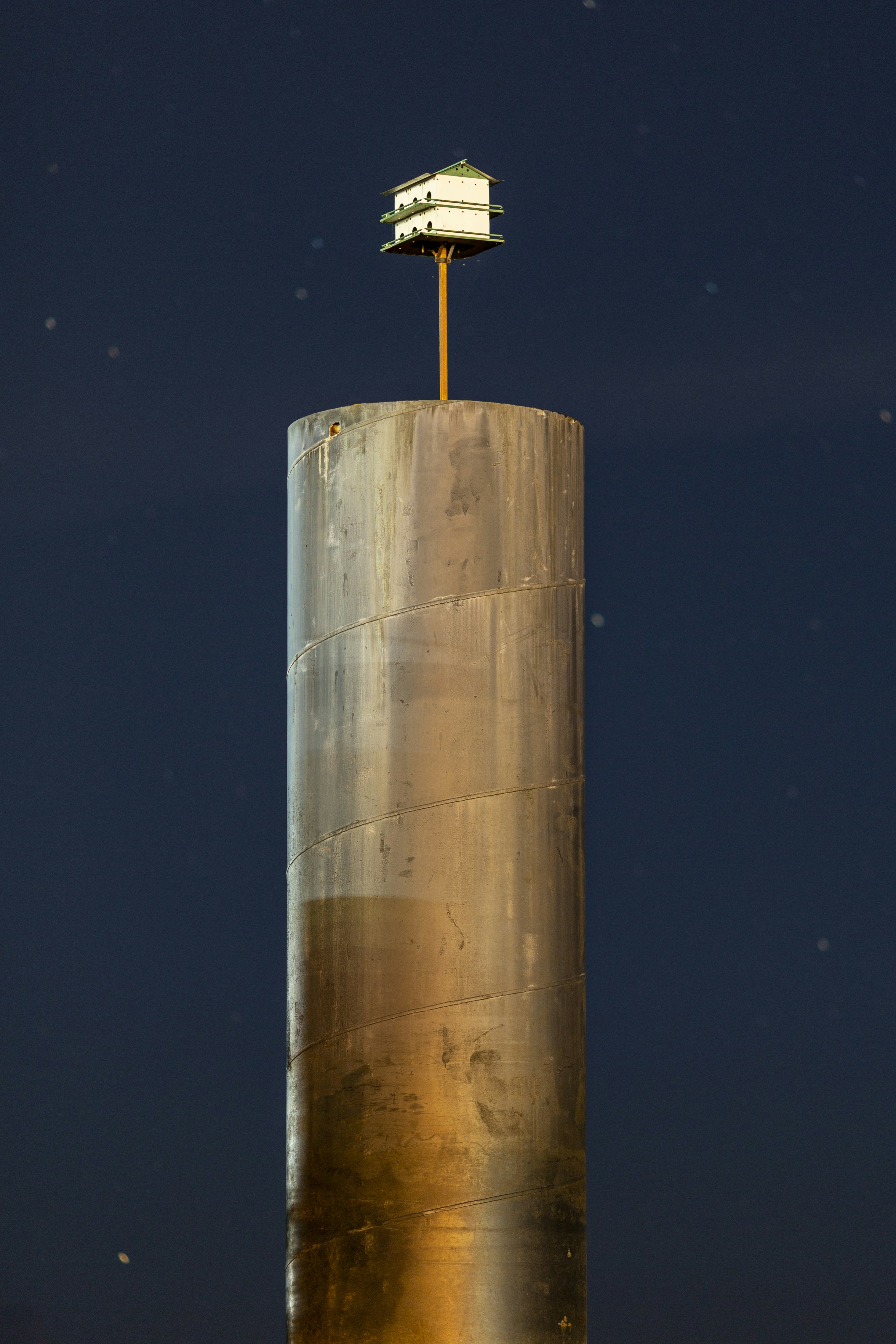Night Beacon: A solitary lamp atop a weathered tower