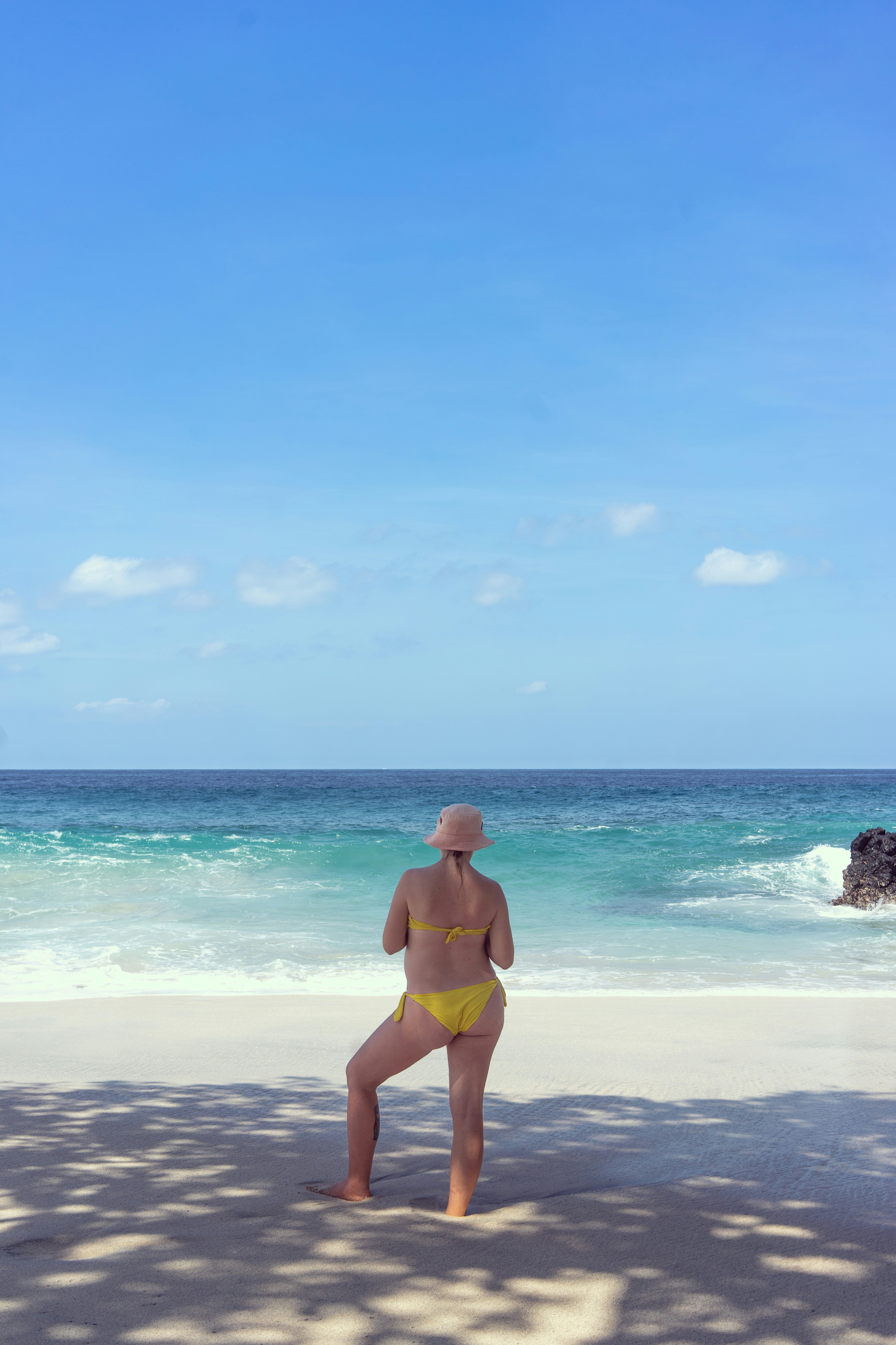 Yellow Bikini at the Edge of Turquoise: A Quiet Beach Portrait