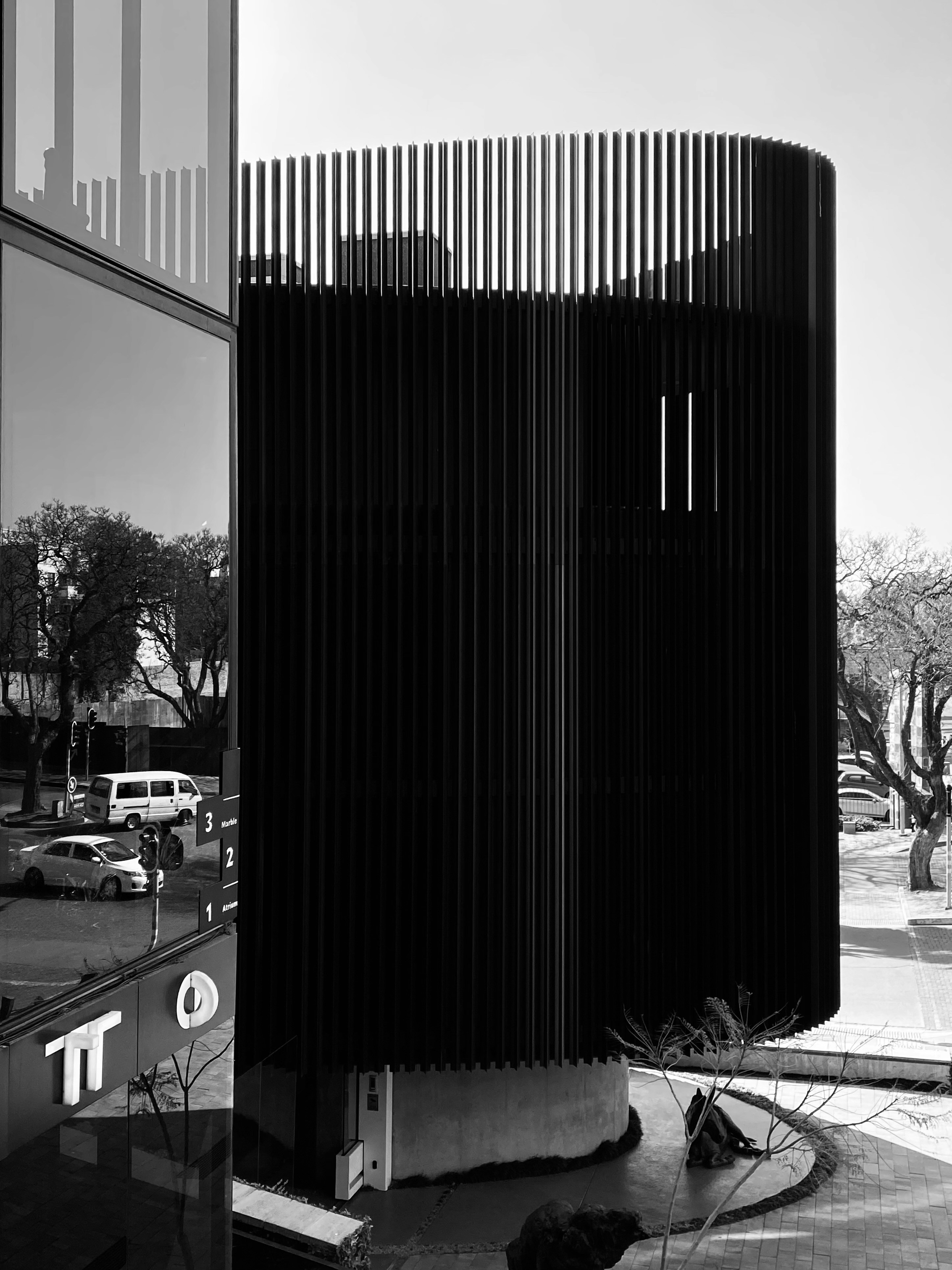 Ribbed Cylinder Framed by Glass: A Minimal Modern Contrast