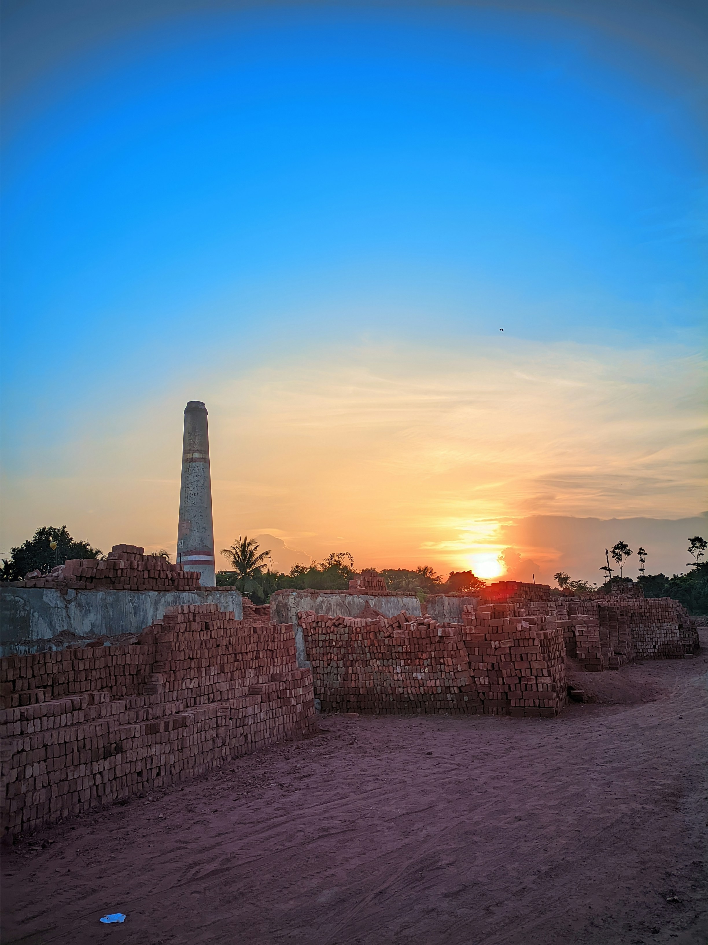 a stone wall with a tower in the background
