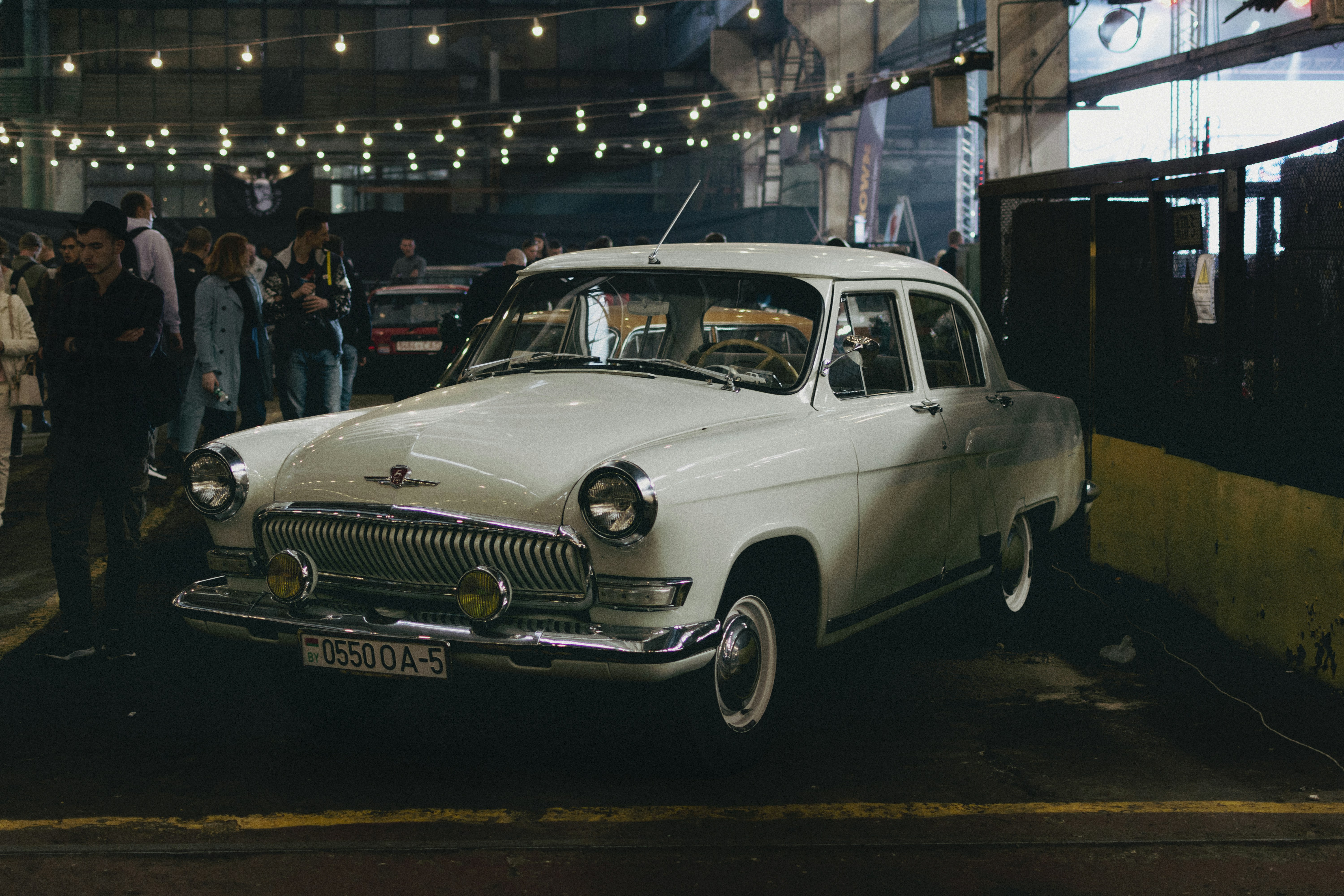 Pobeda in Neon Halo: A 1950s Soviet Classic Beckons Under Warehouse Lights