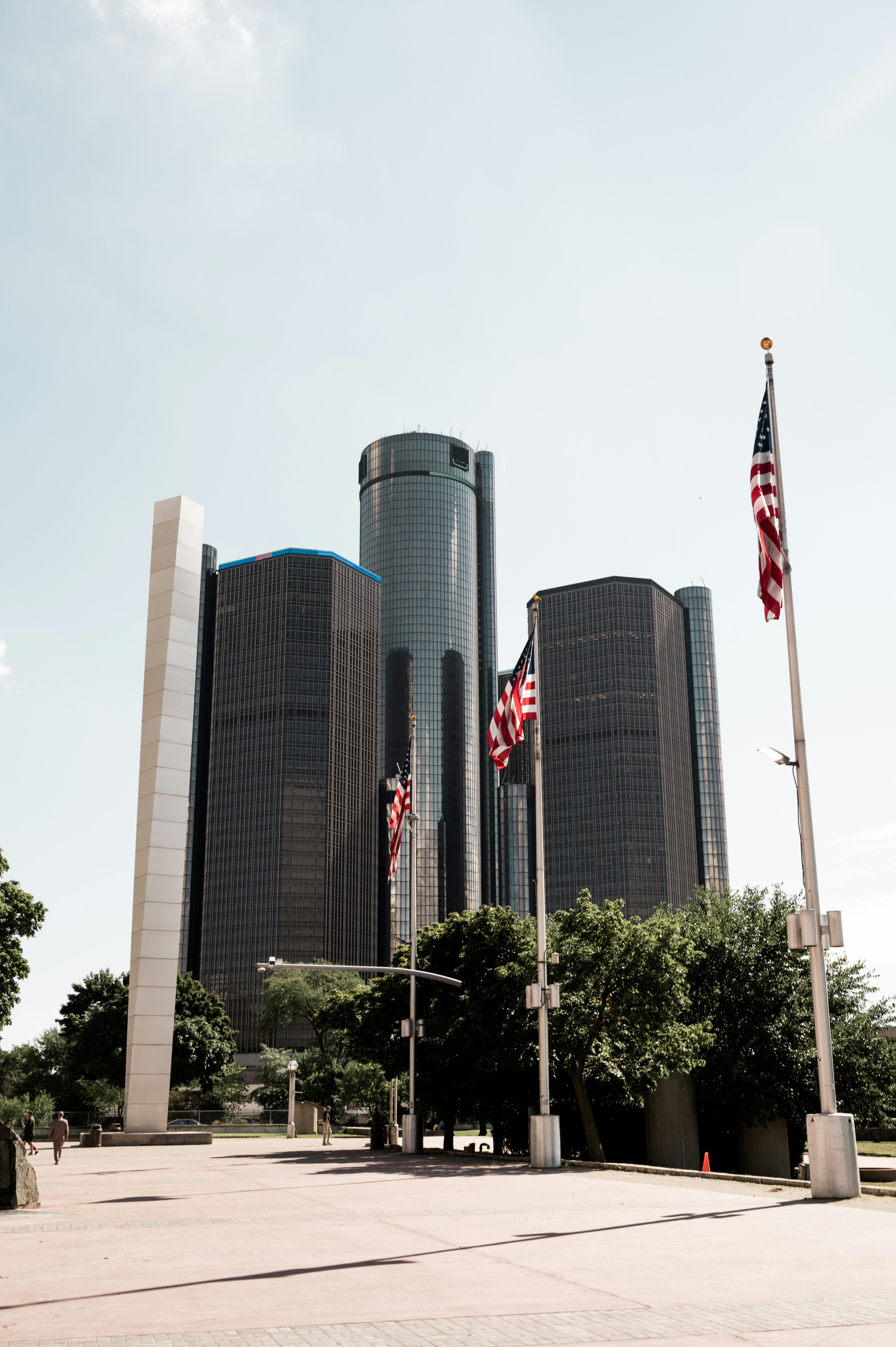 A group of tall buildings with Renaissance Center in the background ...