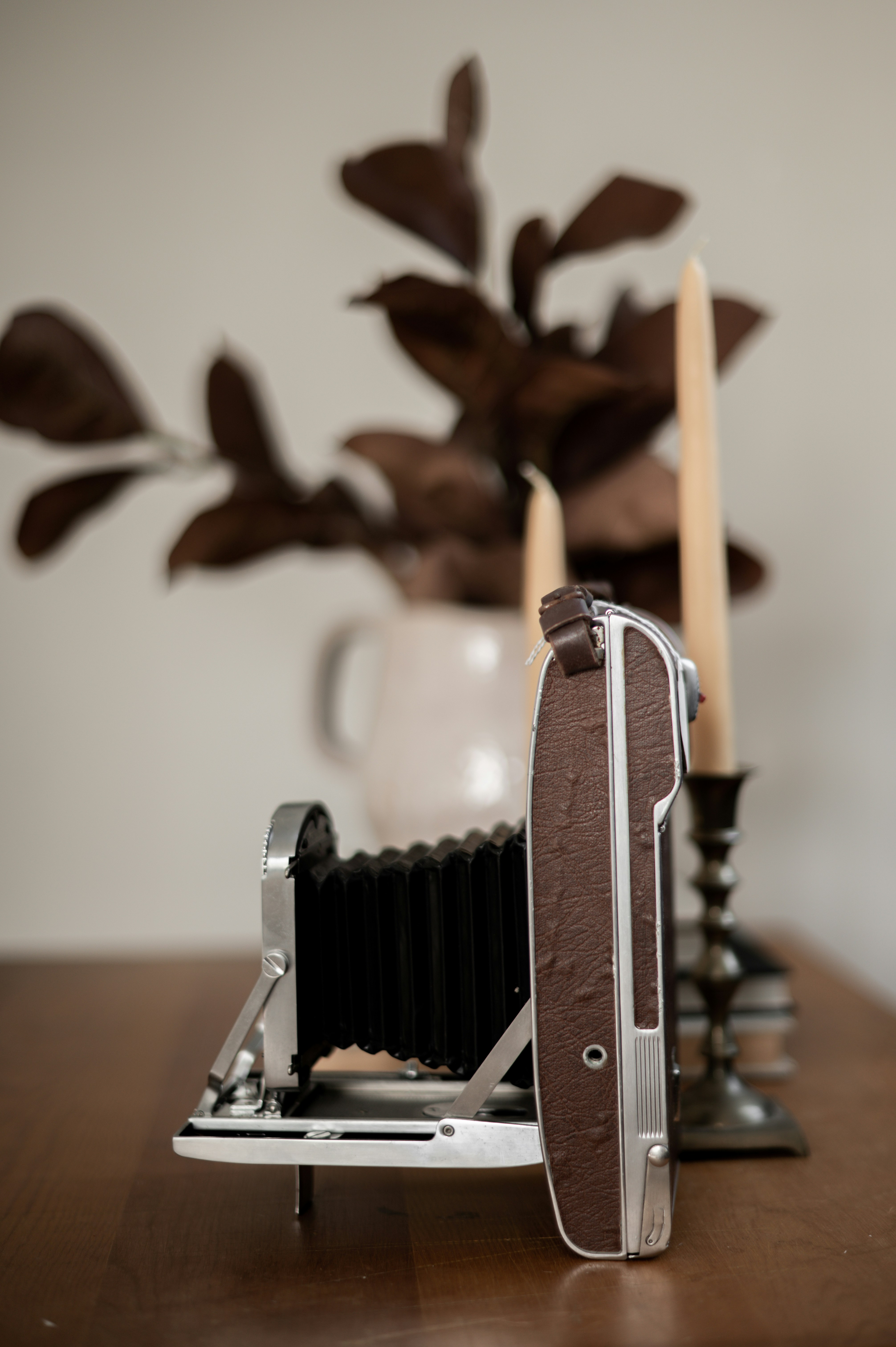 a couple of candles sit on top of a table