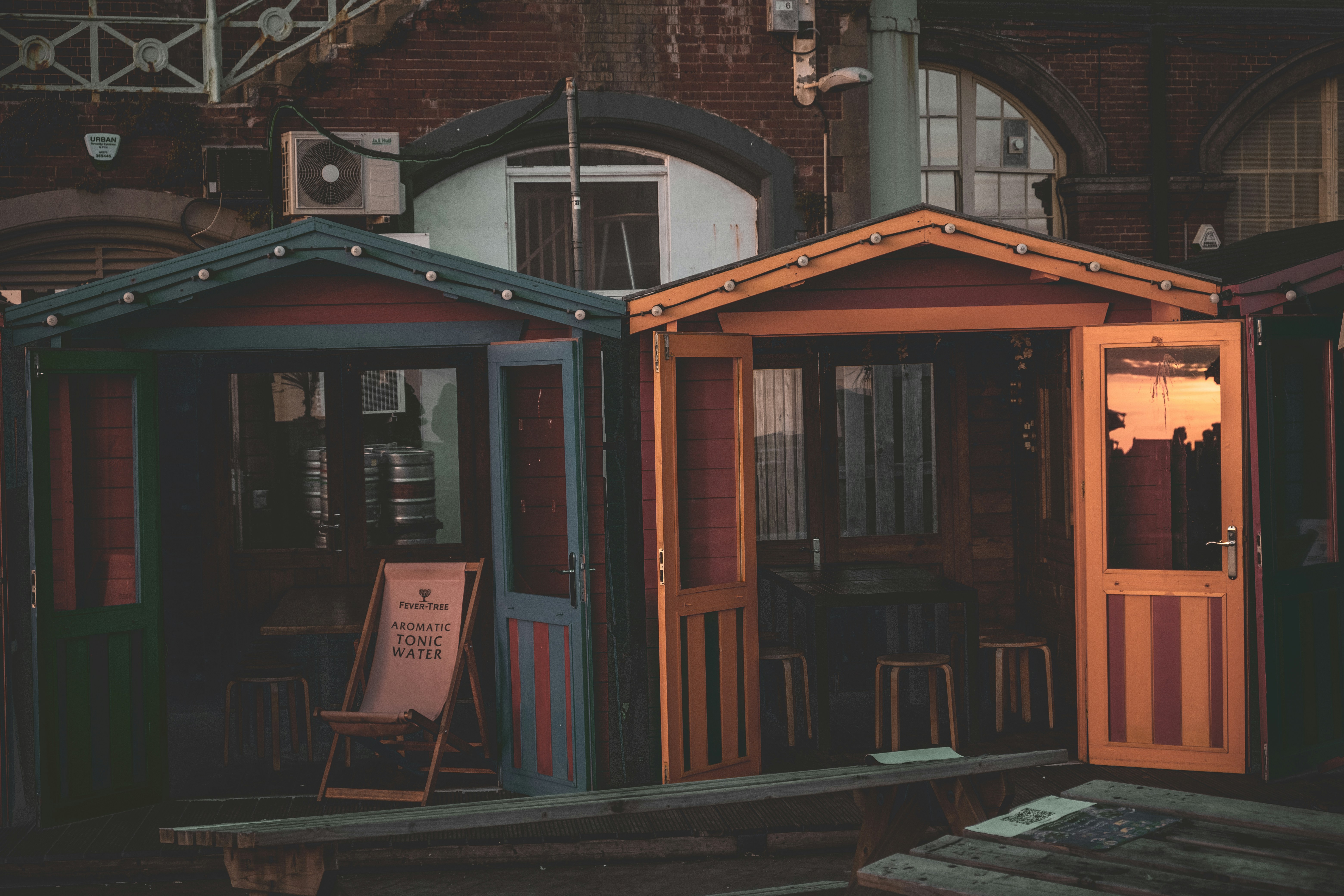 Dusk Doors of Color: A Row of Market Stalls Emitting Warm Glow