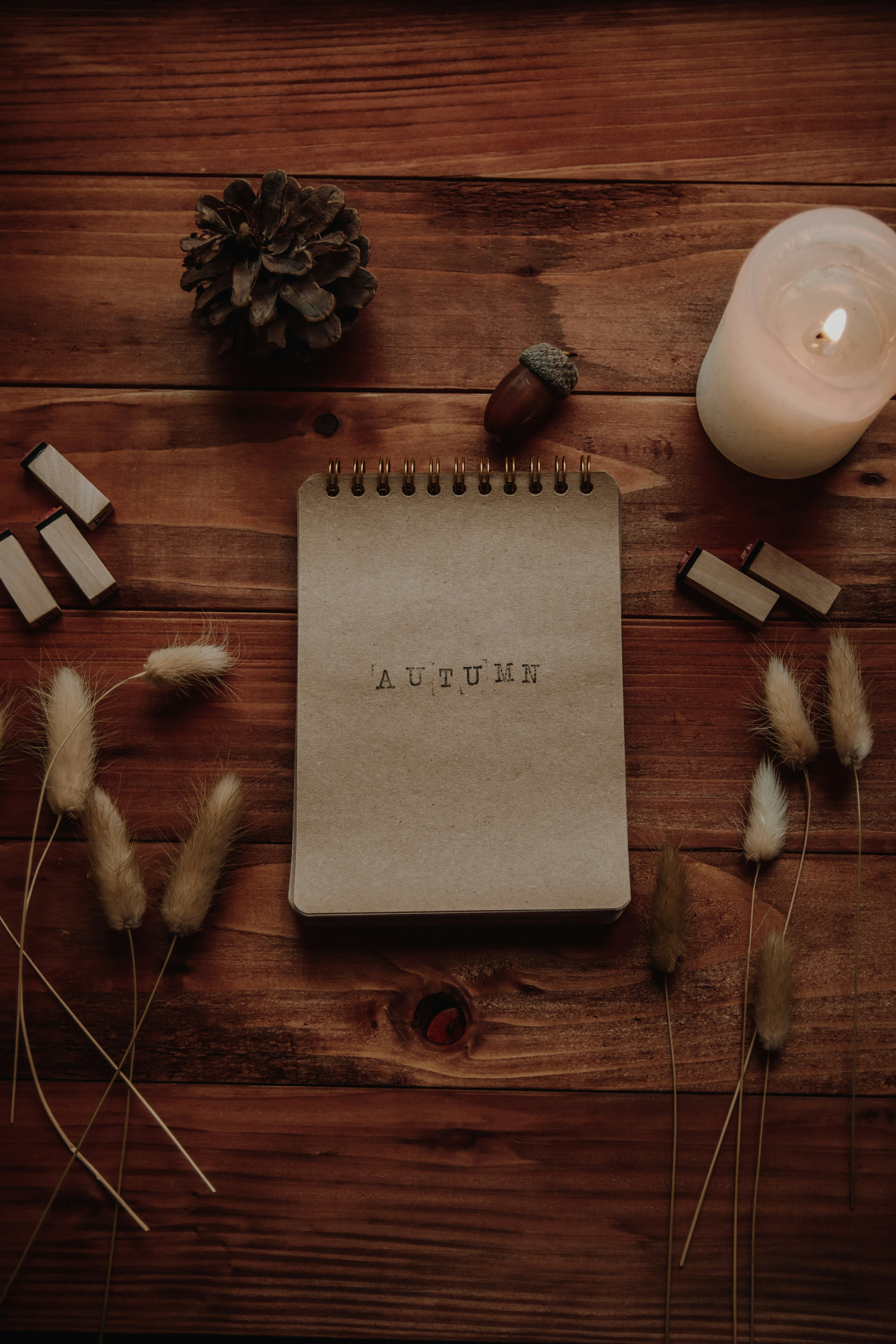 a table with a card and a candle and a flower on it