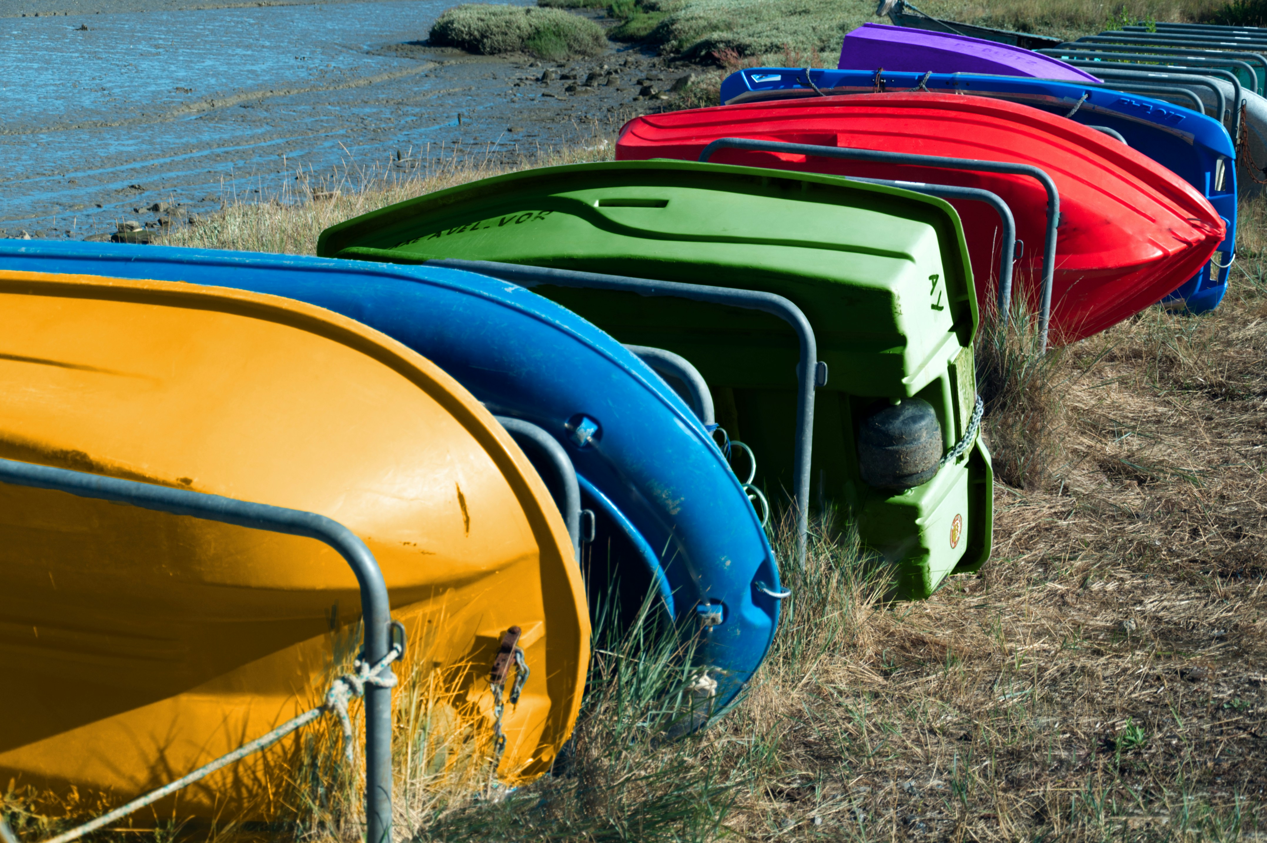 a couple of kayaks on the shore of a lake