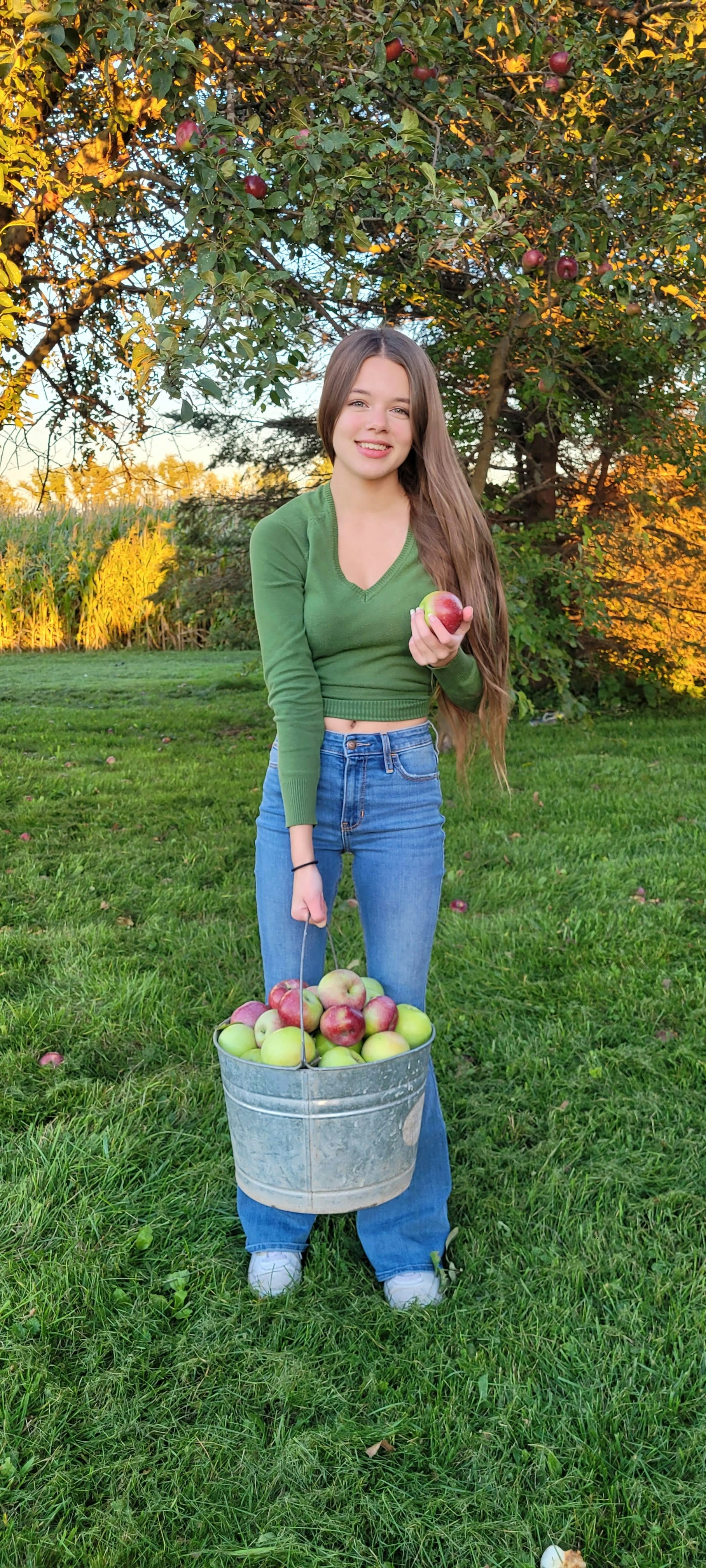 My daughter in law picking apples in our orchard.