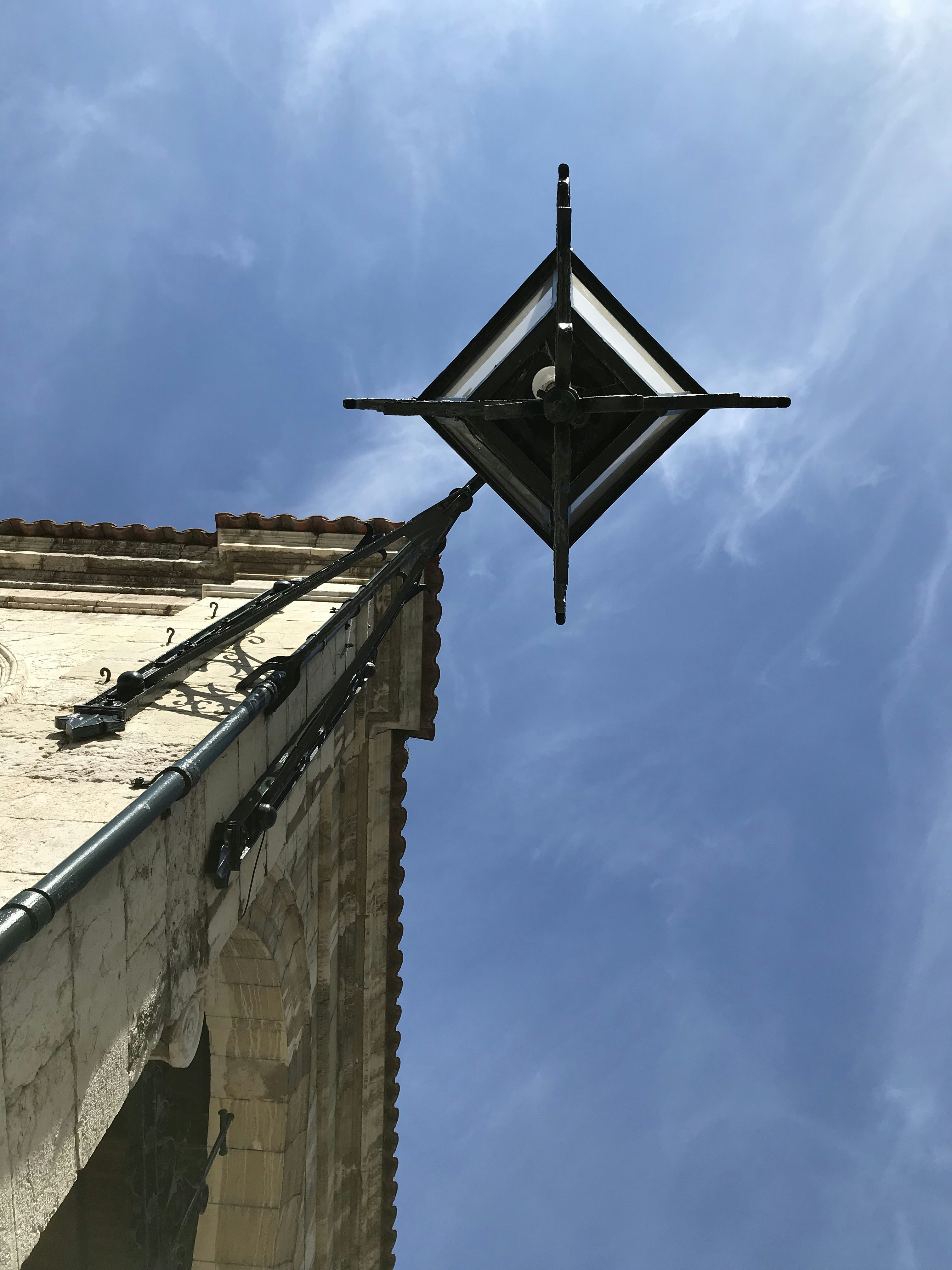 Lantern at the Tip: A Low-Angle Study of Stone and Sky