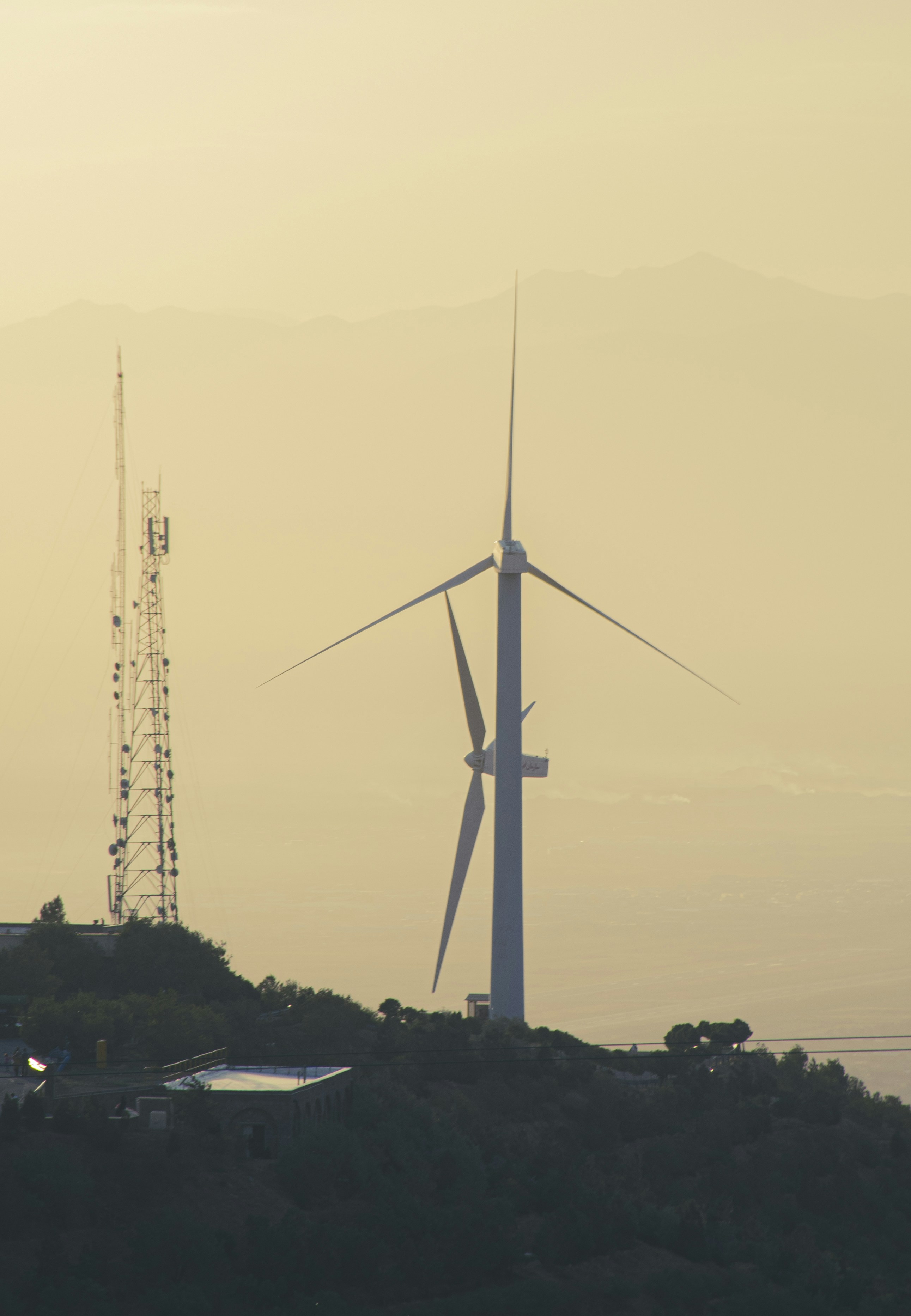 A windmill and a tower photo – Free Turbine Image on Unsplash