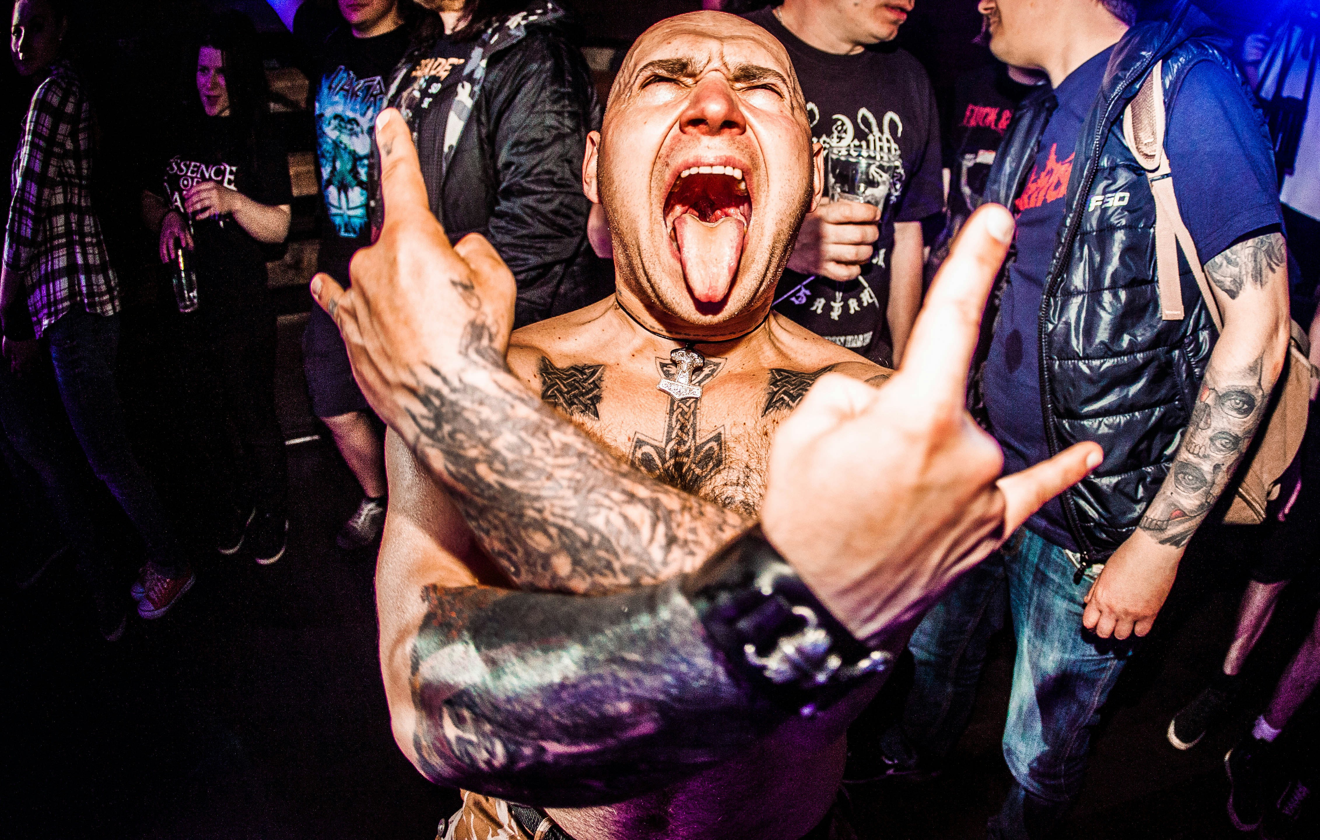 Energetic Frontman: Tattooed fist and yell in a crowded pit