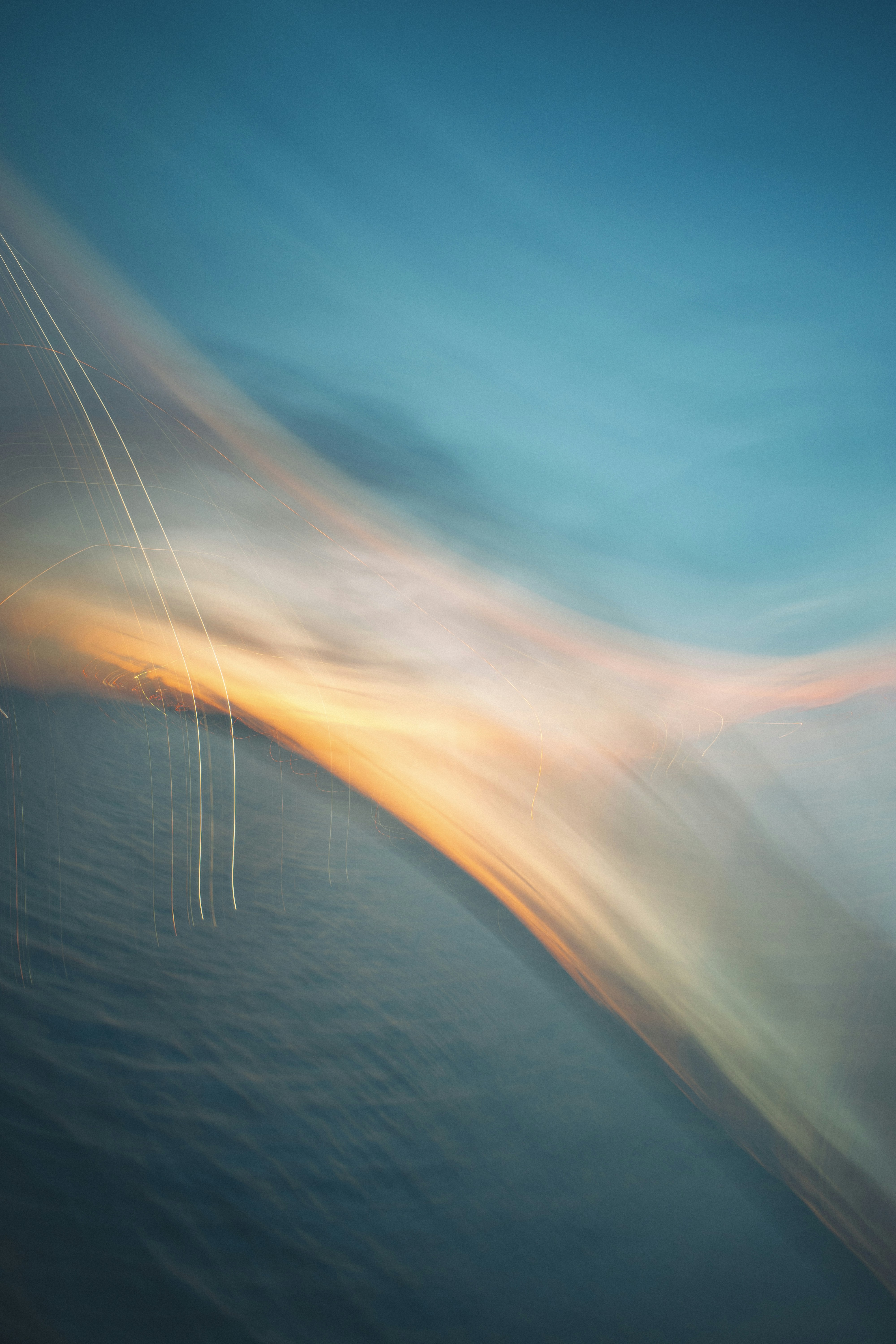 Ember Arc Skimming the Teal Sea in a Blur of Sunset