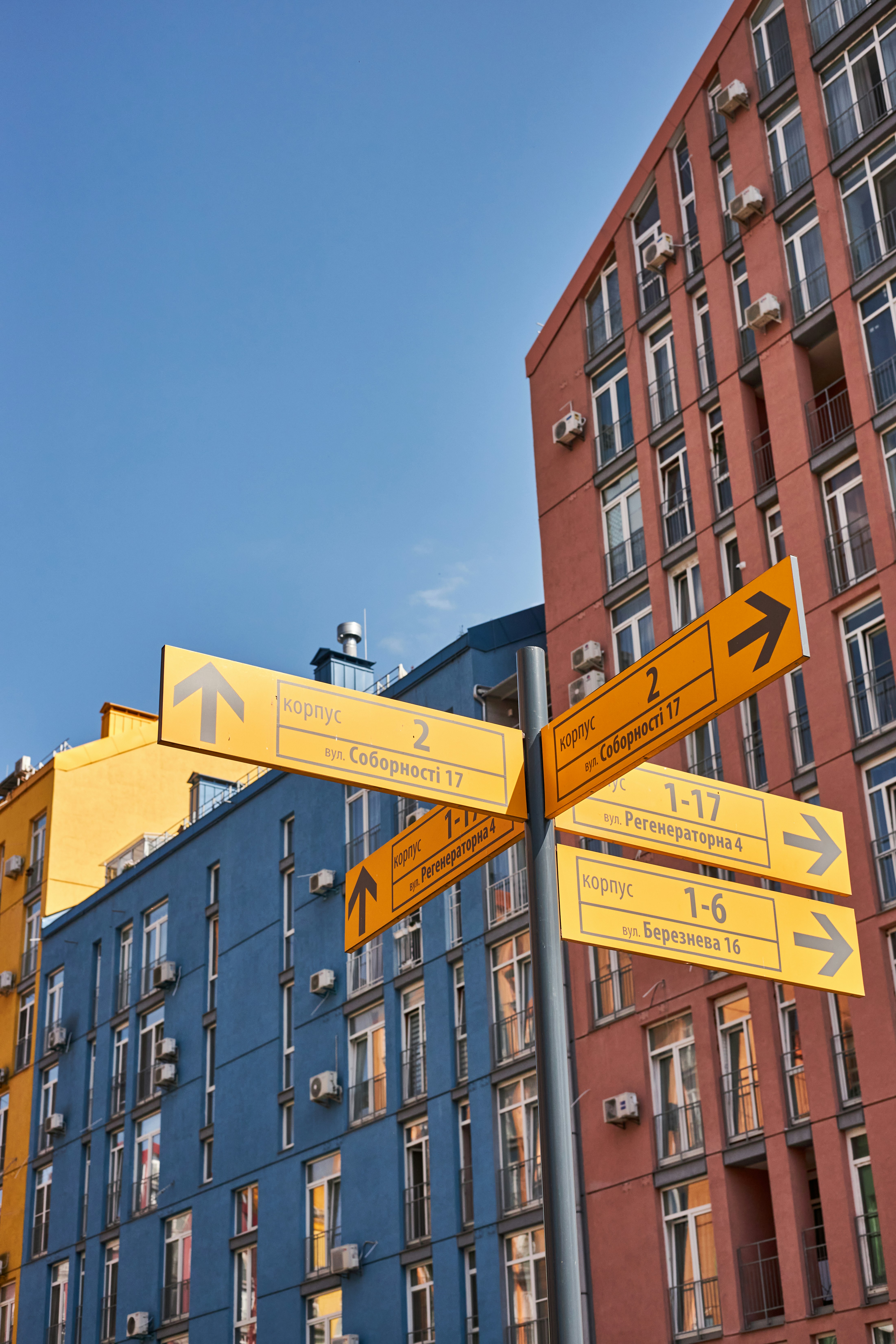 Yellow Signpost Mosaic: City Directions Under a Blue Sky