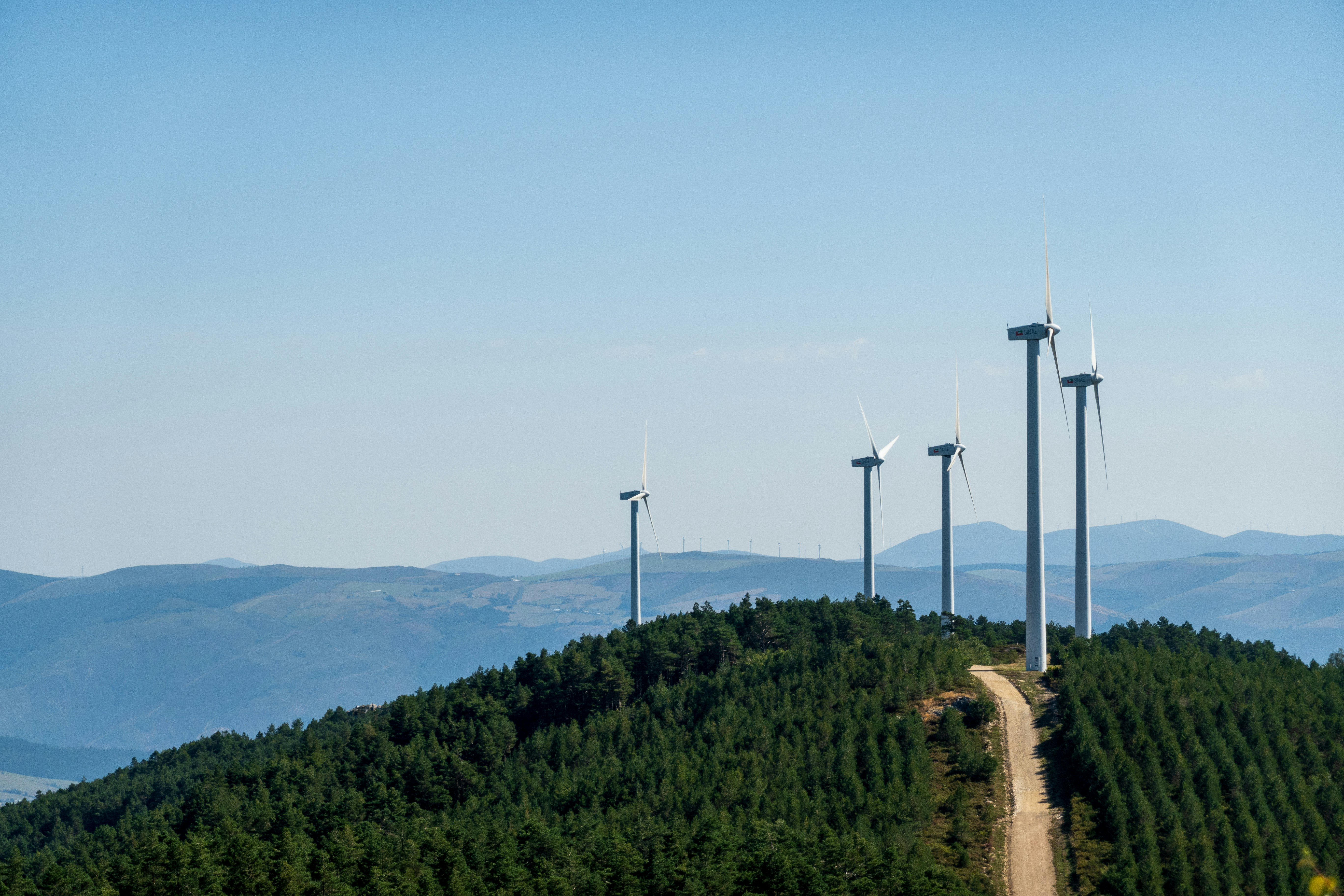 A group of wind turbines on a hill photo – Free Spain Image on Unsplash