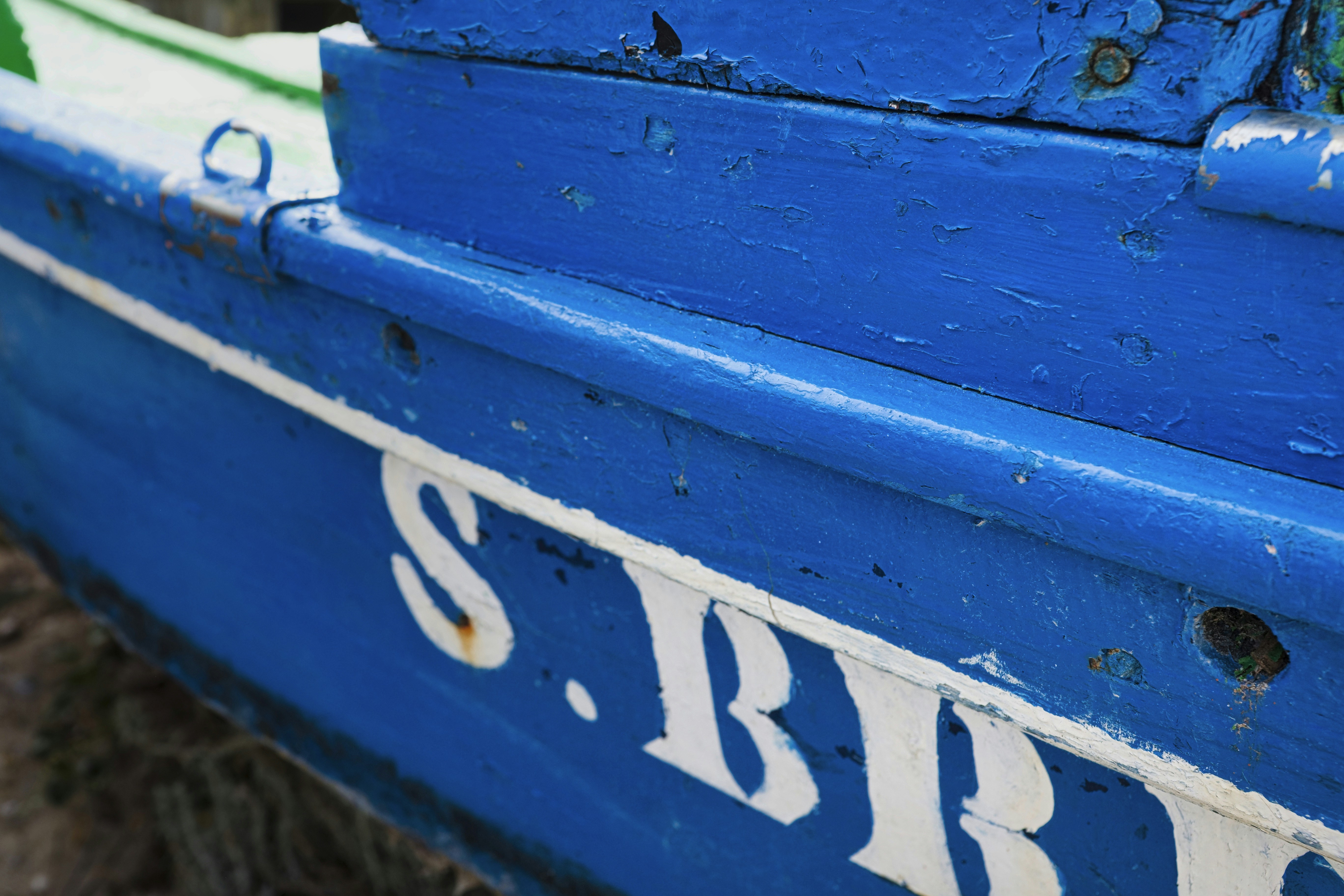 S.B.R. on a Weathered Blue Hull: Texture of a Seaside Boat