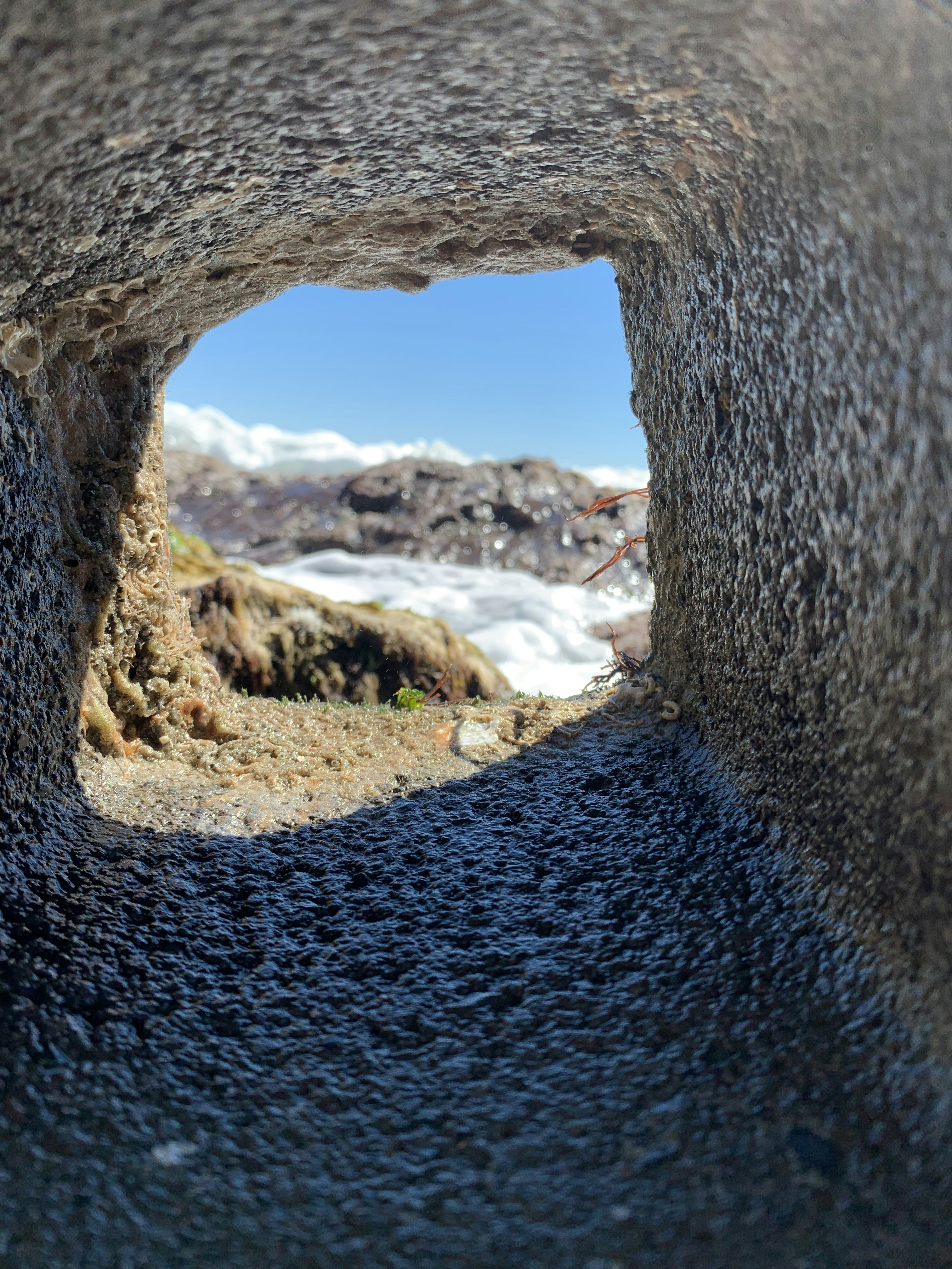 A view through a hole in a rock wall photo – Free Hole Image on Unsplash