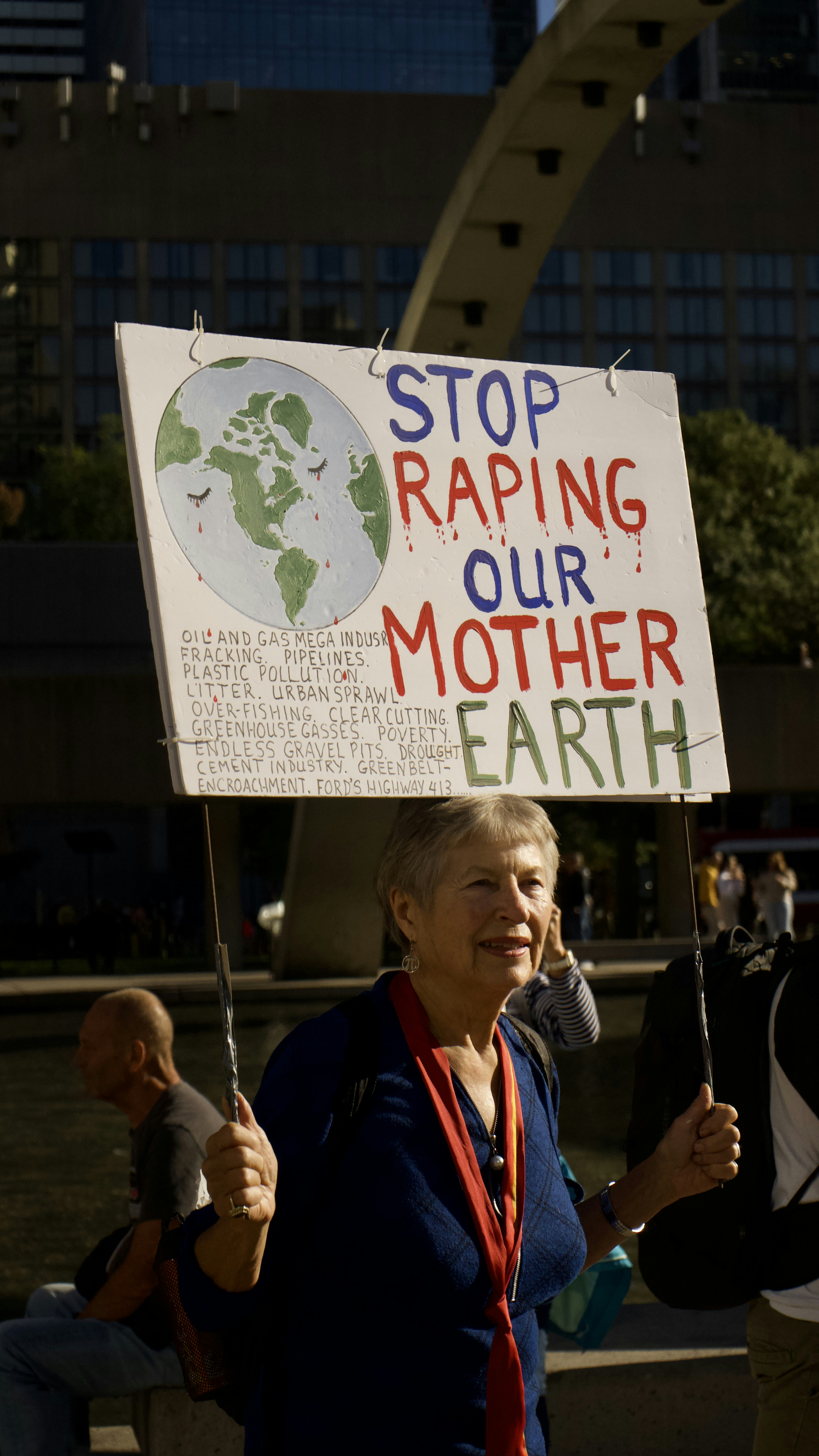 Earth Banner Protest: A City Sign Demands Respect for Our Mother Planet
