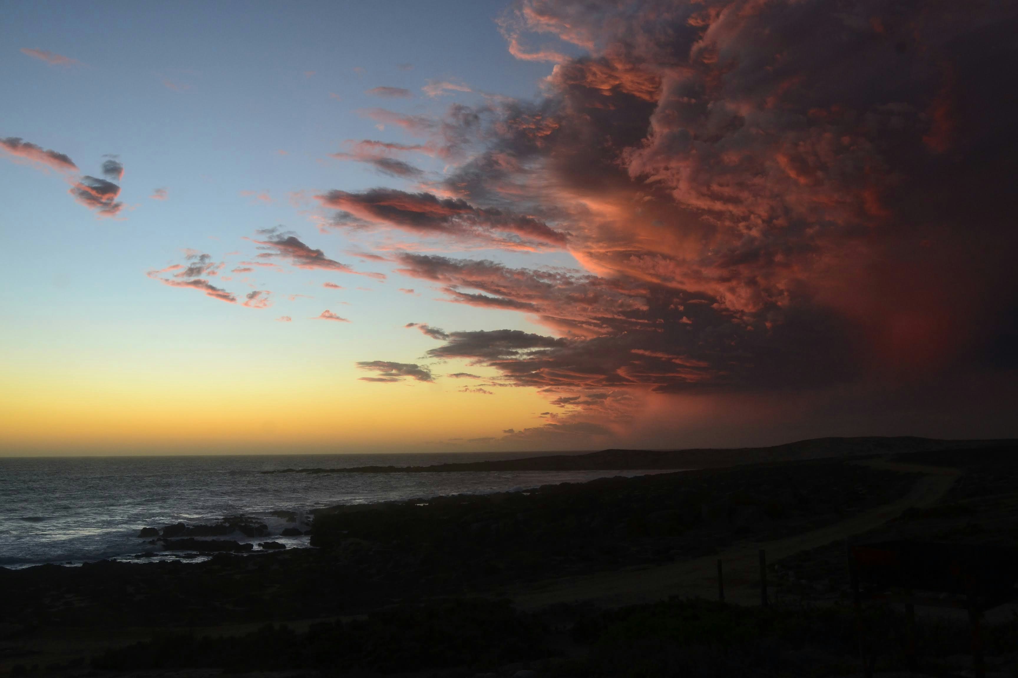 Amber Horizon Over a Quiet Coastal Cliff at Sunset